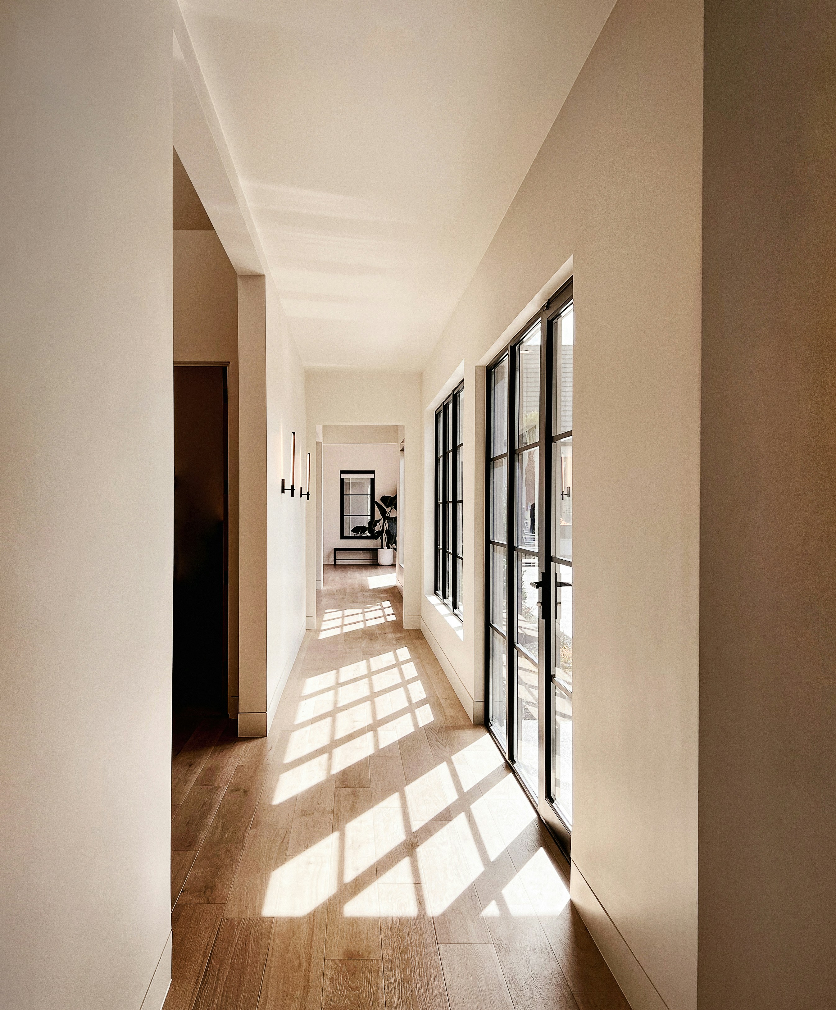 A long hallway with large windows and wooden floors photo – Free ...