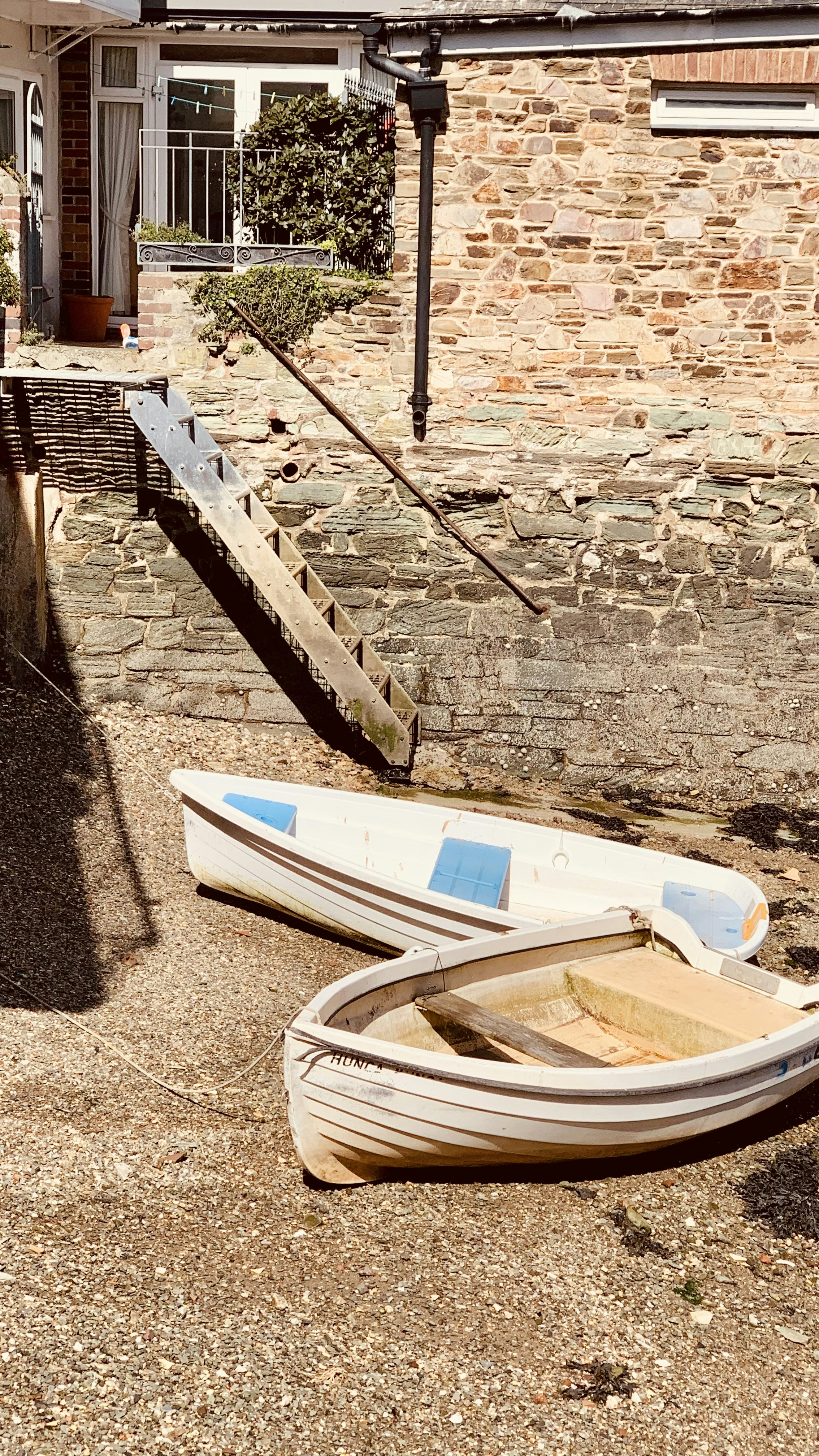 A couple of boats sitting on top of a dirt field photo – Free Devon ...