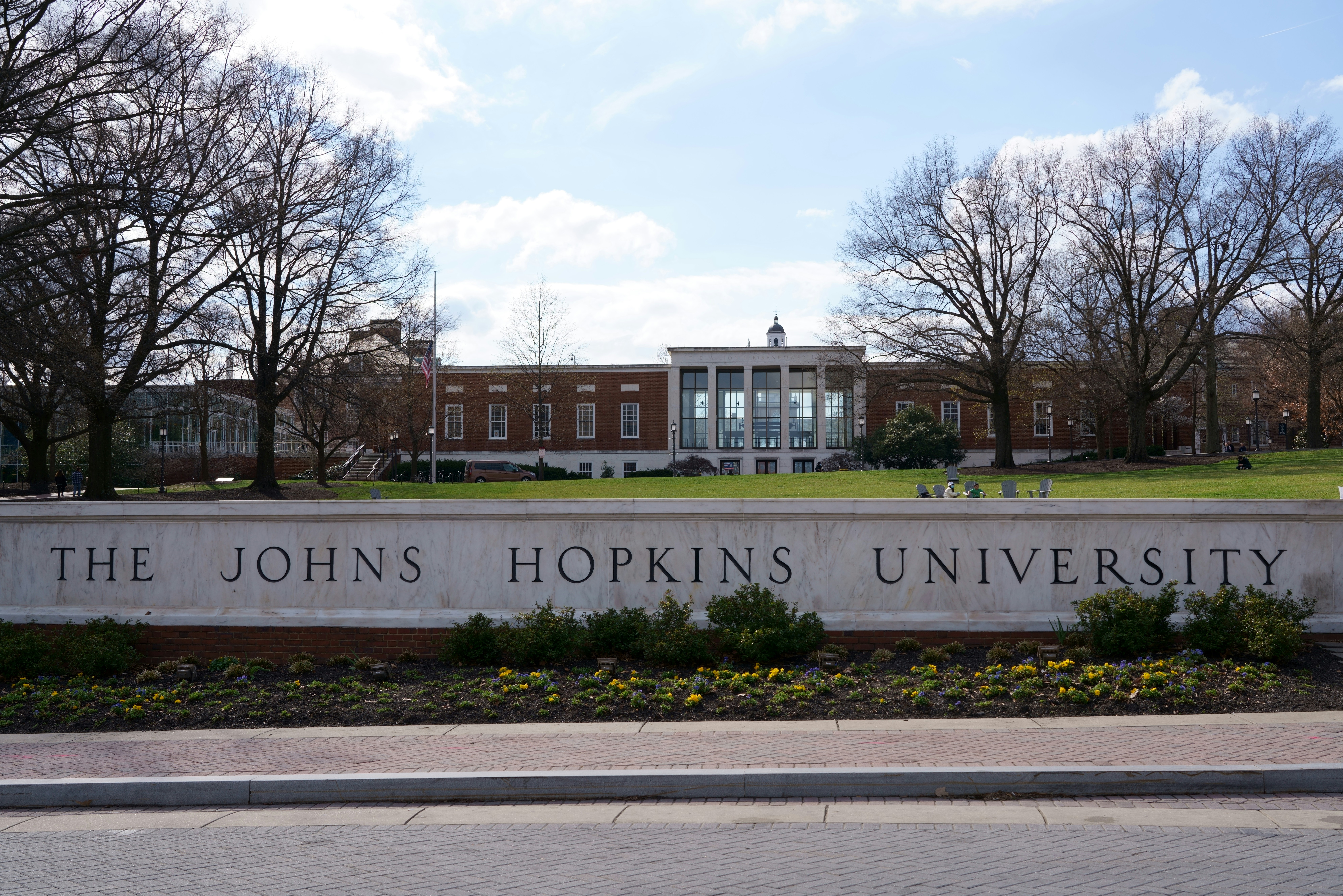 The johns hopkins university sign in front of a brick building photo ...