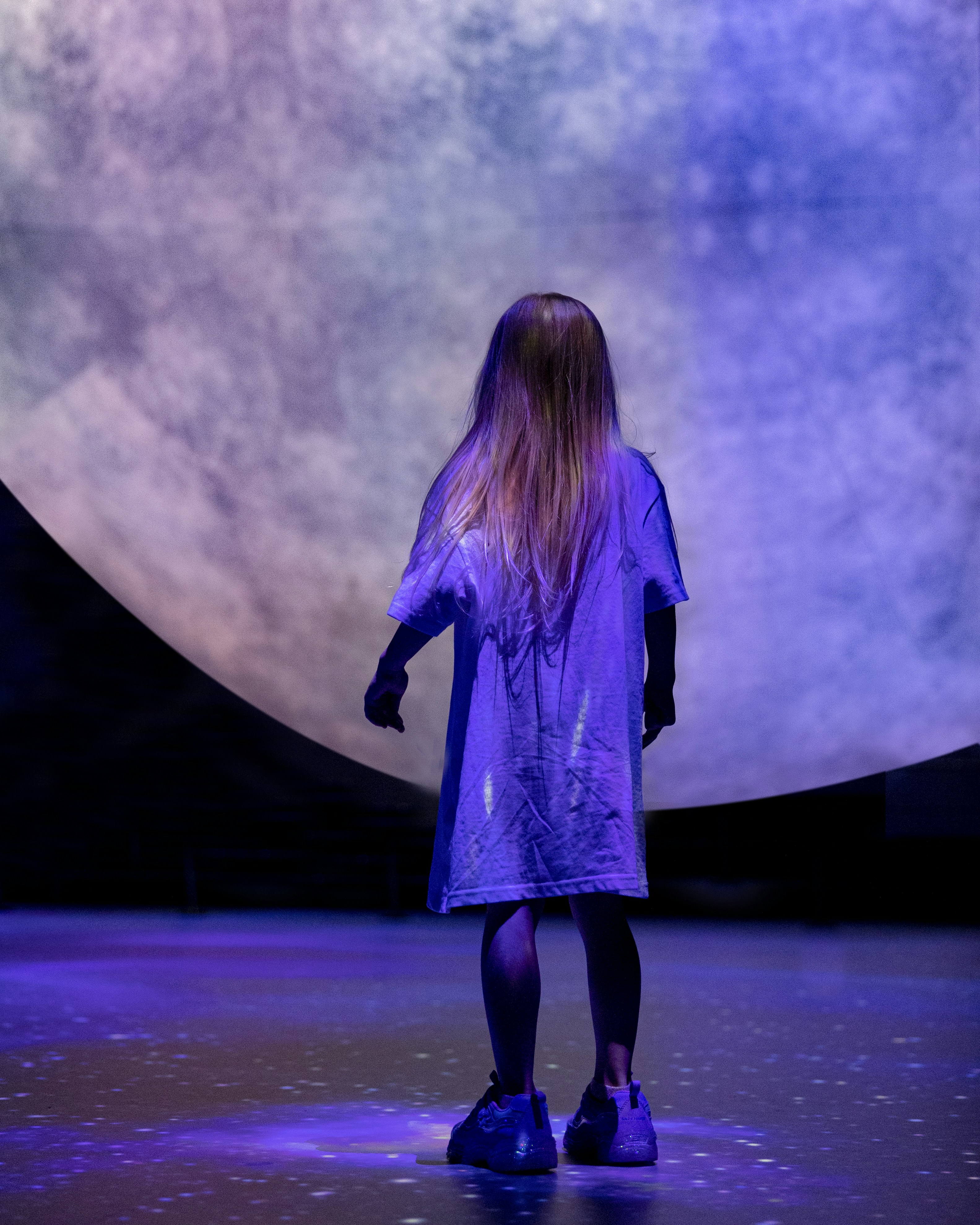 Backlit Figure in a Cosmic Stage