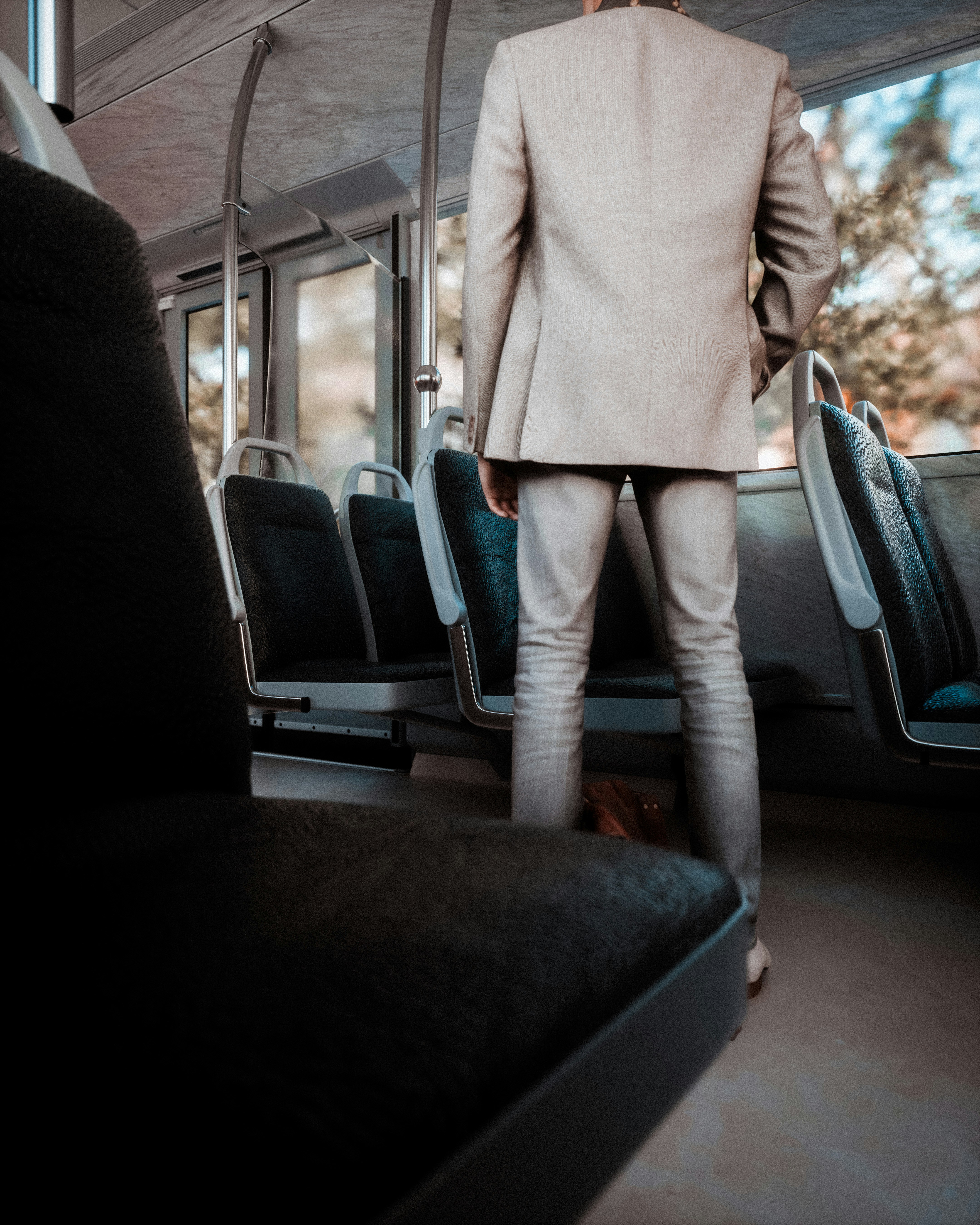 A man in a suit standing on a bus photo – Free Render Image on Unsplash