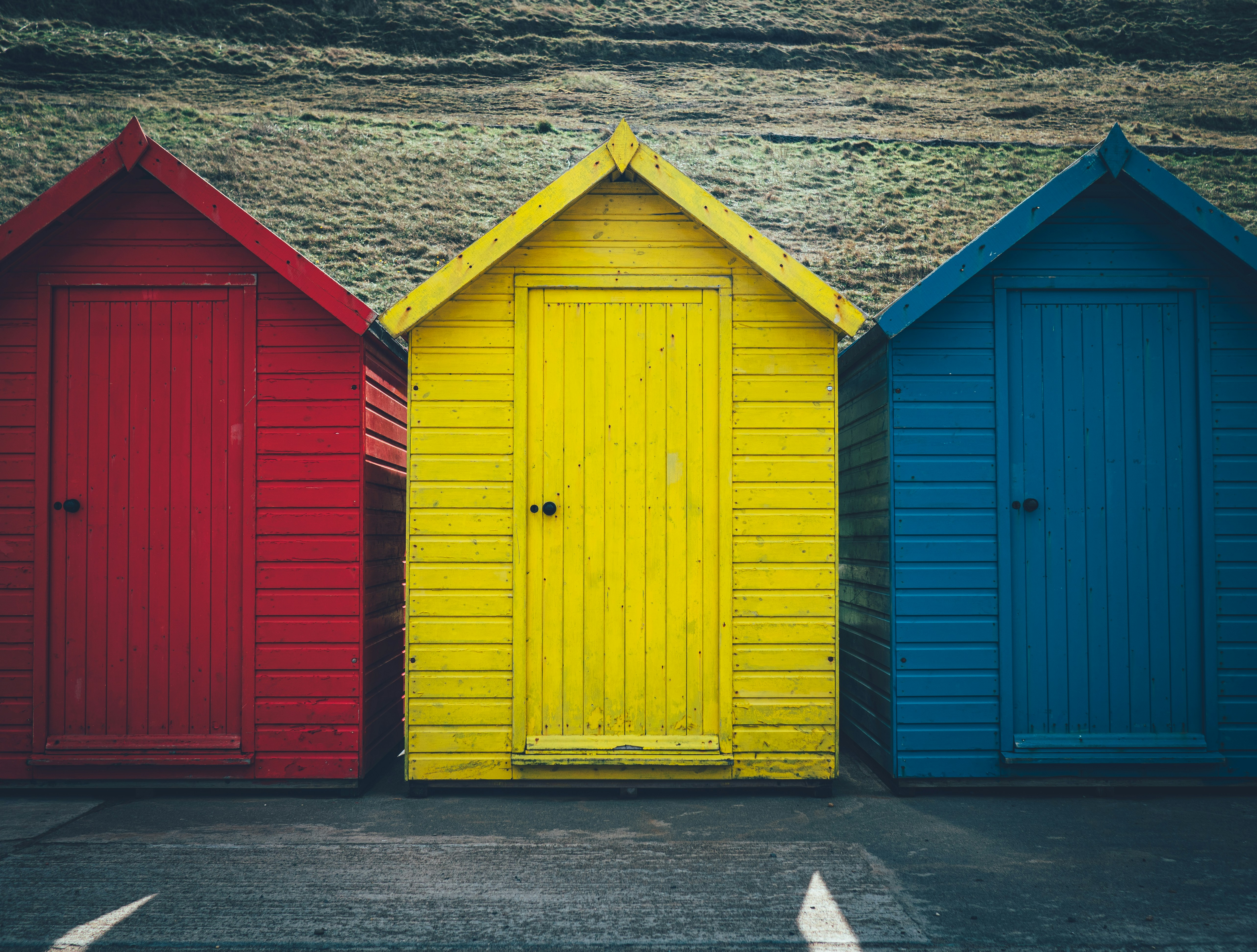 A row of colorful beach huts sitting next to each other photo – Free ...