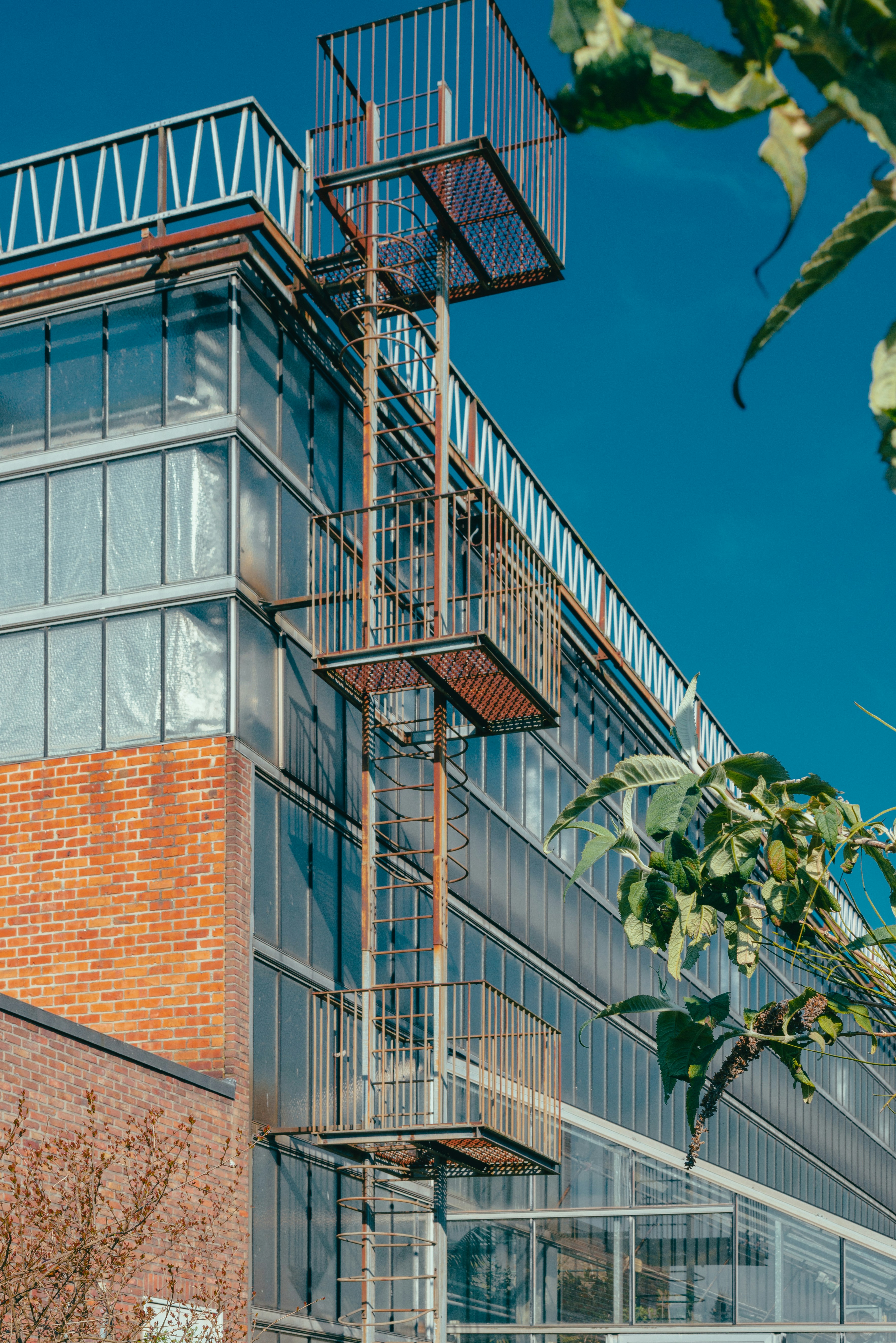 a tall building with a fire escape on top of it
