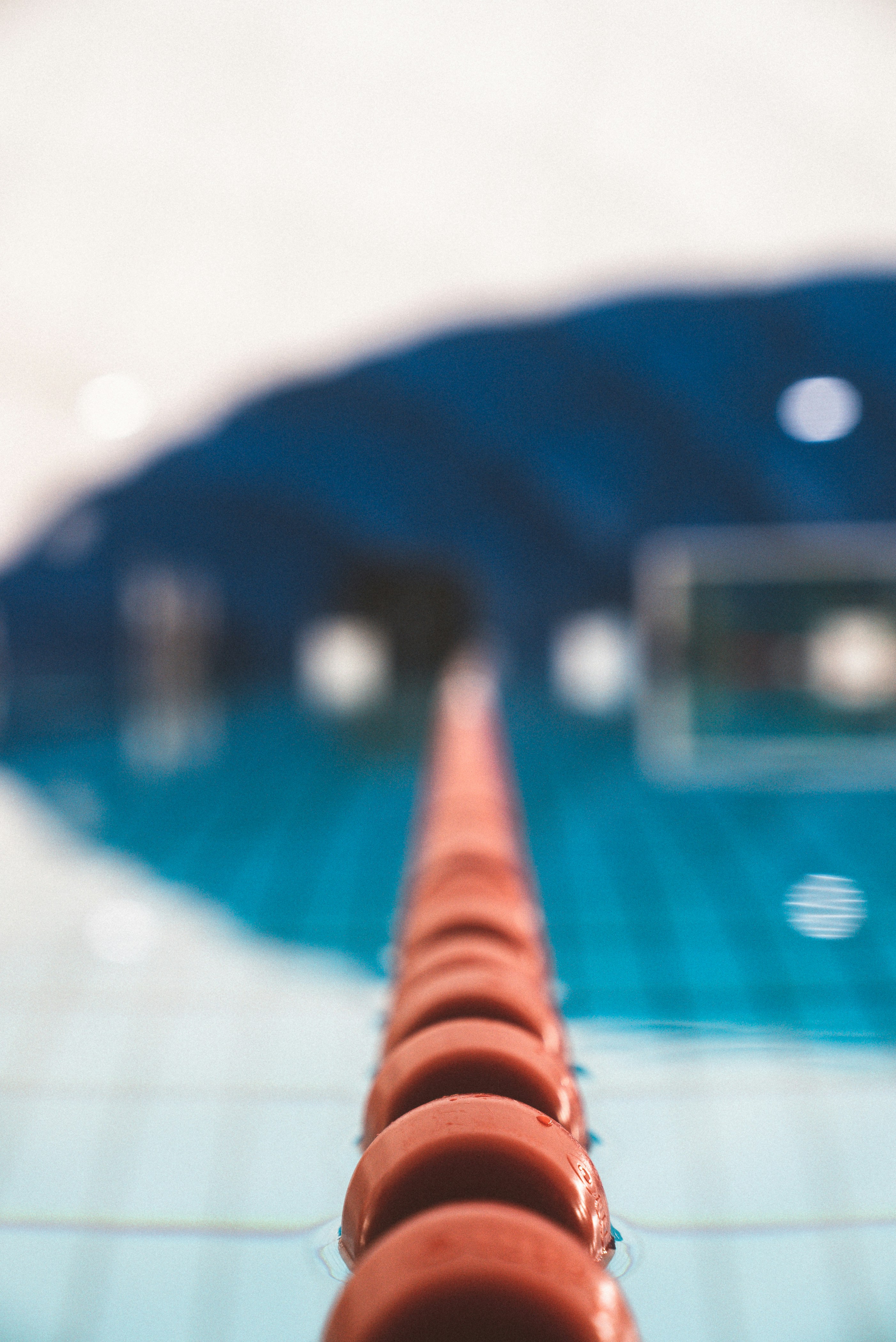A pool with a long row of red pipes next to it photo – Free Water Image ...