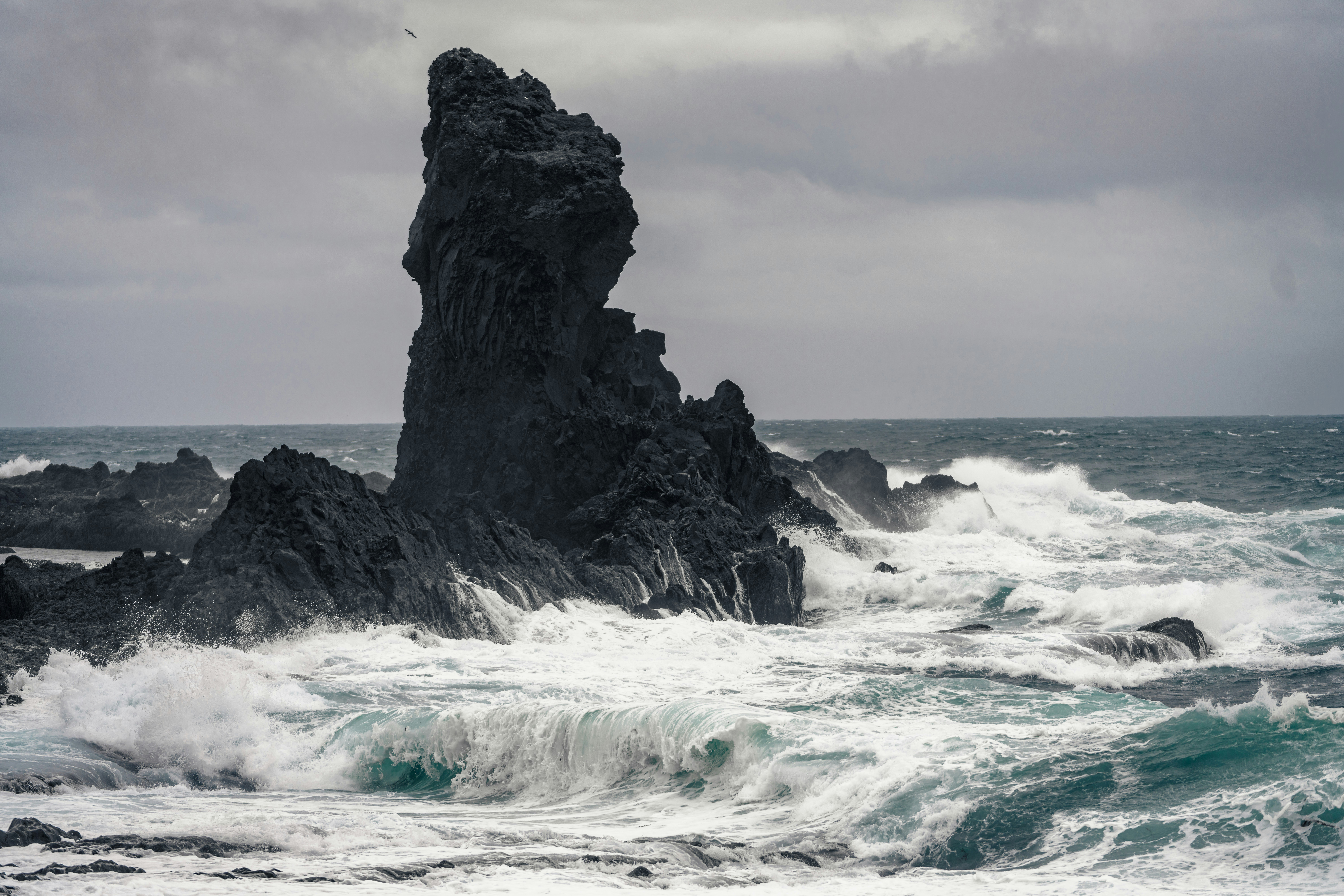 A large rock sticking out of the ocean photo – Free Iceland Image on ...