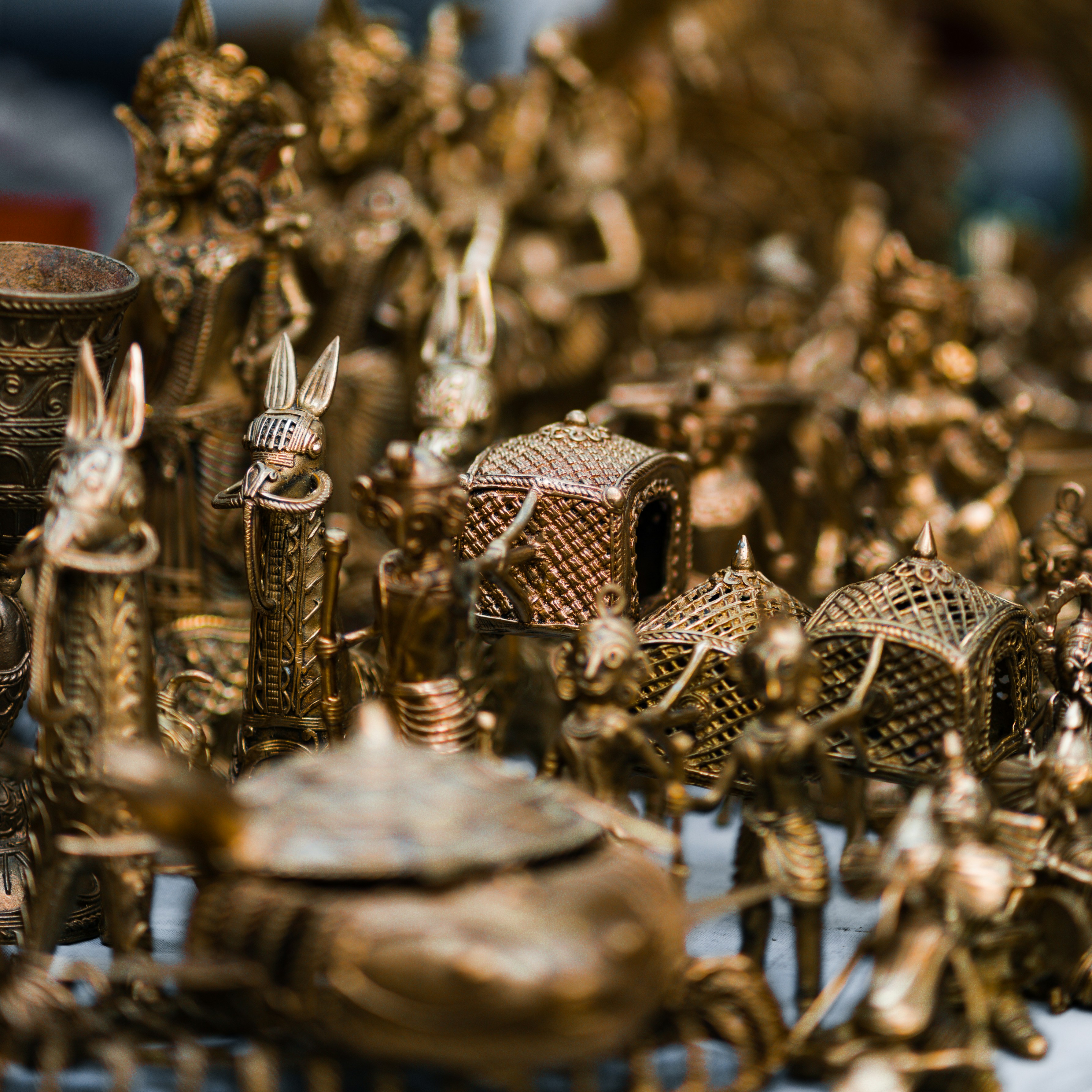 A table topped with lots of gold colored items photo – Free Image on ...