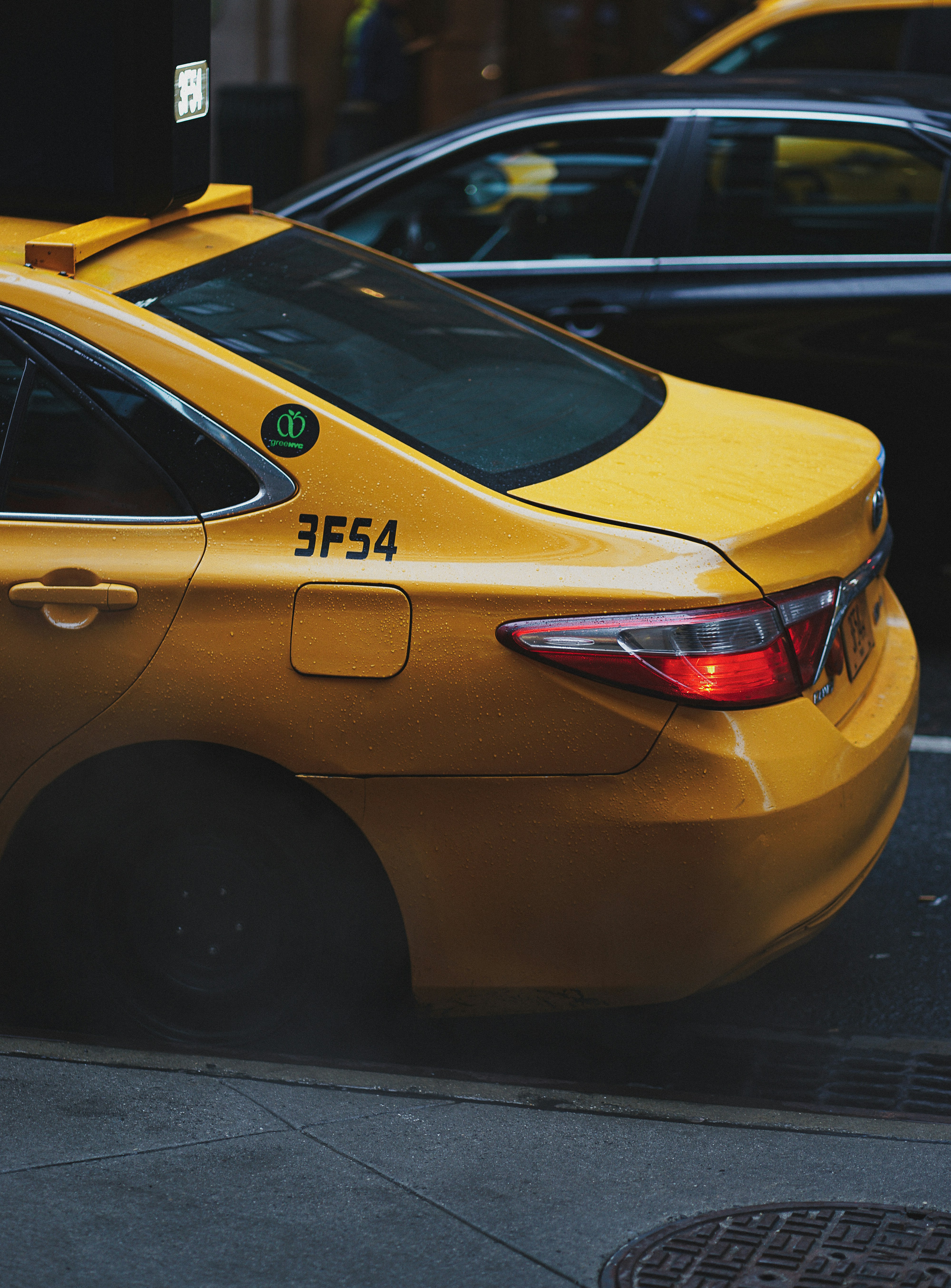 A yellow taxi cab parked on the side of a street photo – Free Car Image ...