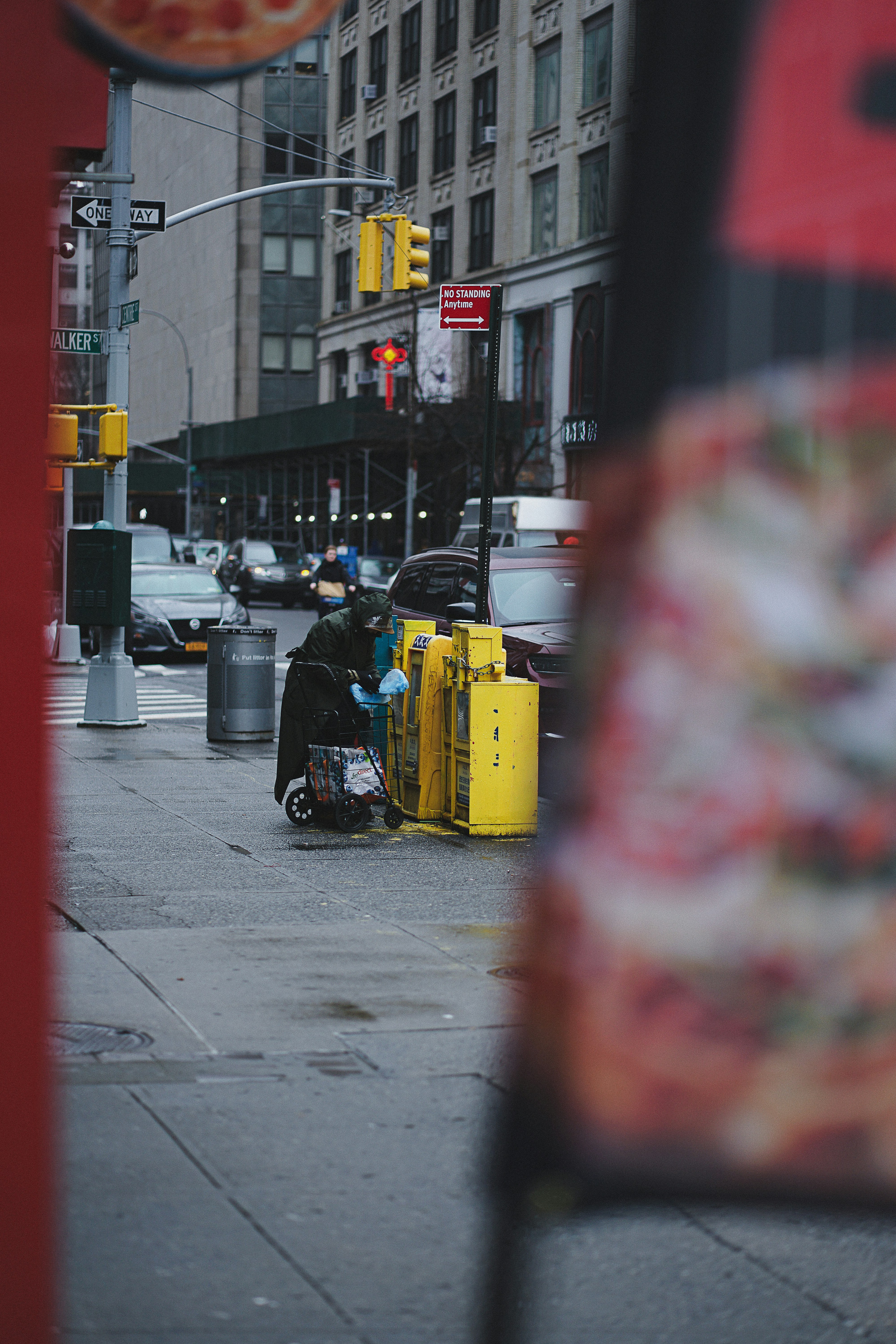 Yellow Barrier and Street Vendor Stand in a Busy Urban Midday Scene