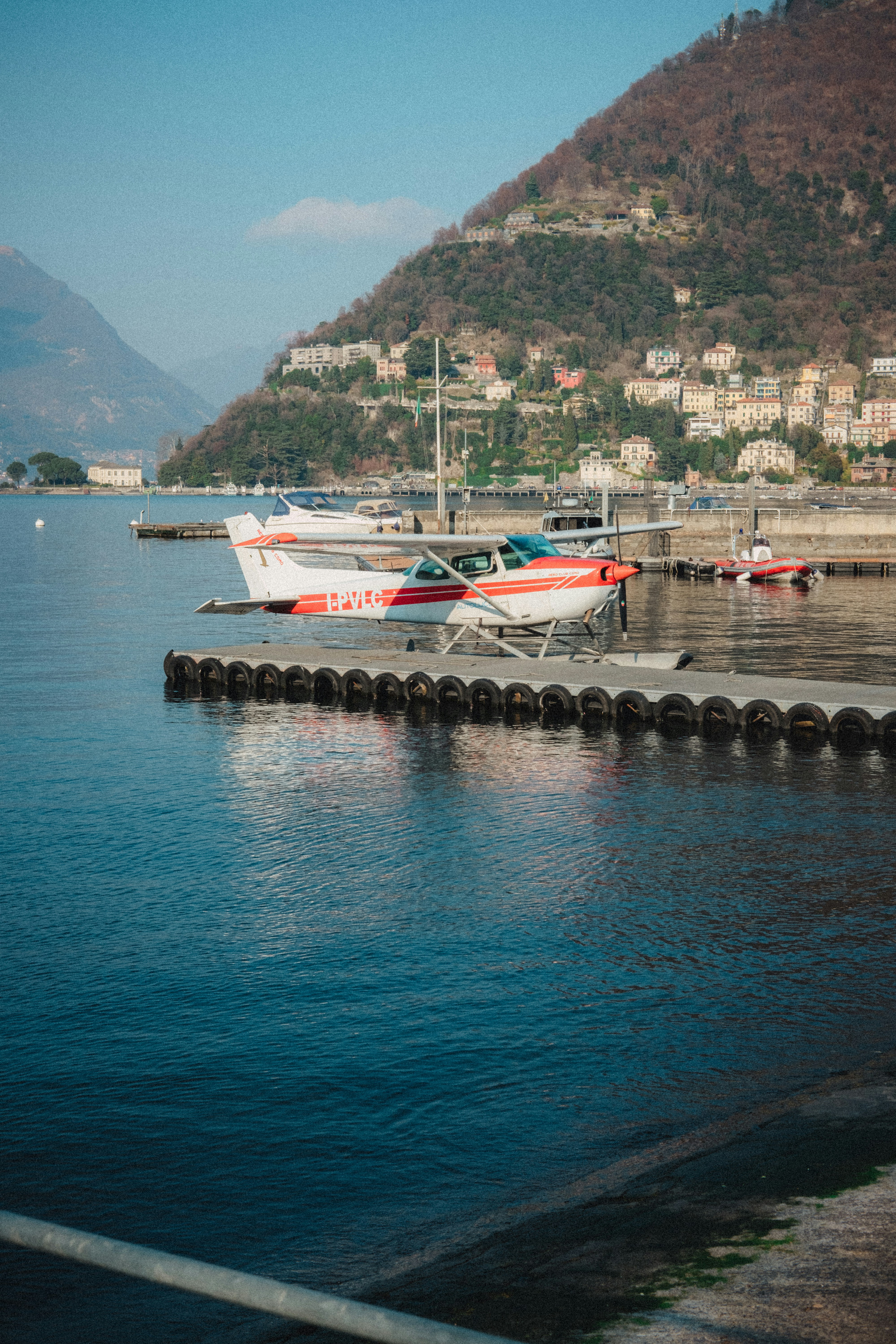 Seaplane at Rest: Quiet harbor framed by hillside village