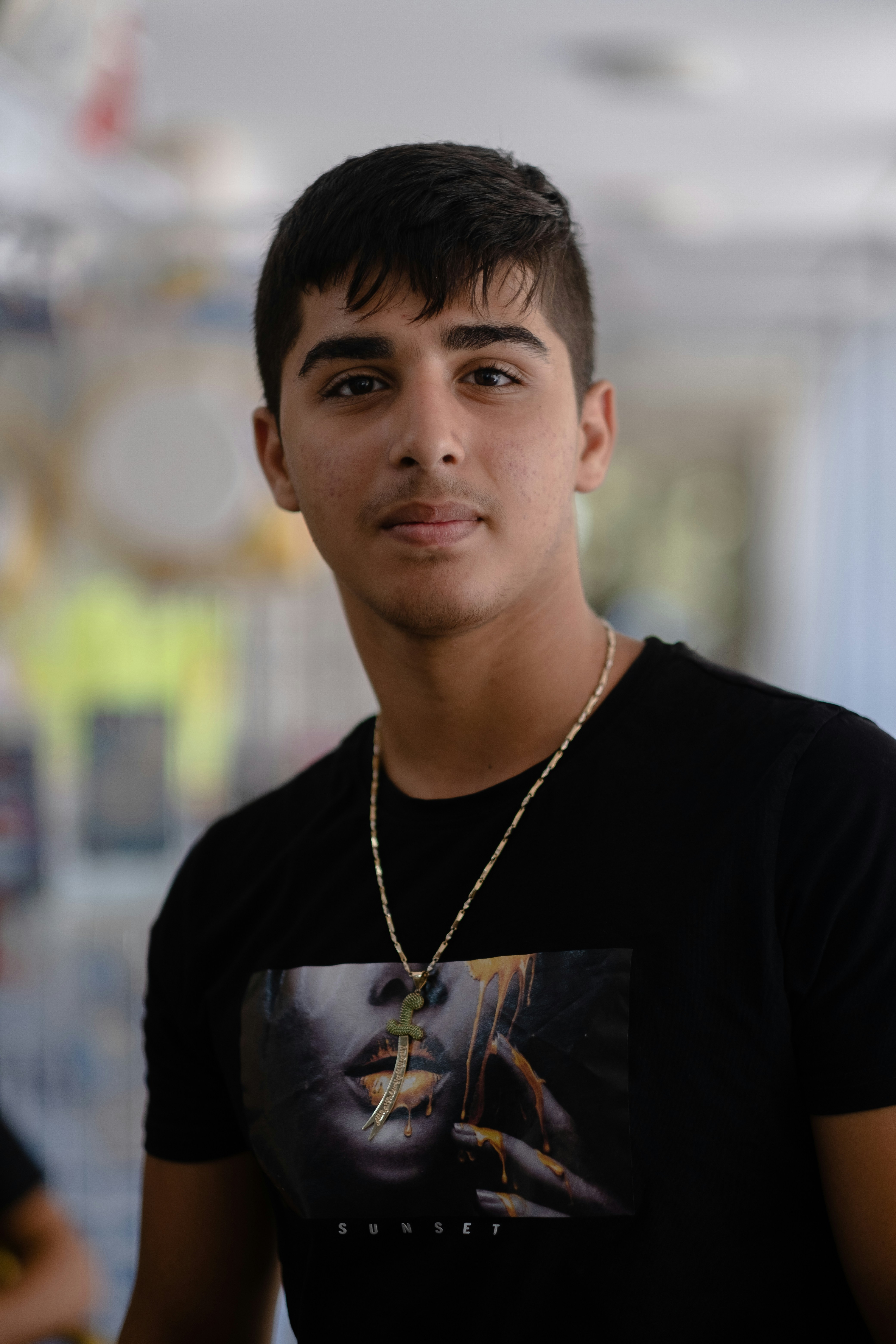 A young man wearing a black shirt and a gold necklace photo – Free ...