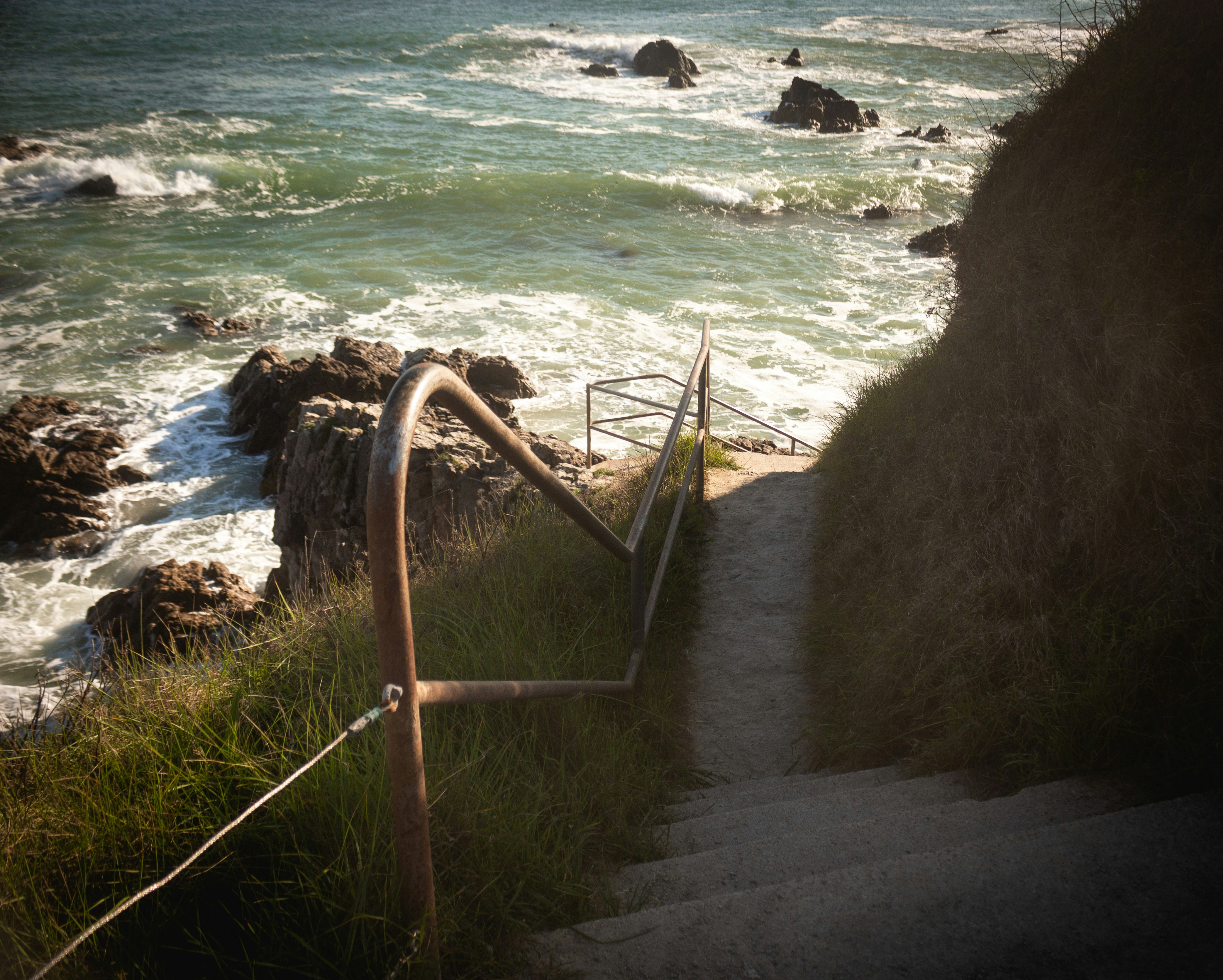 Staircase to the Sea: Weathered Rails Climb a Cliff Edge