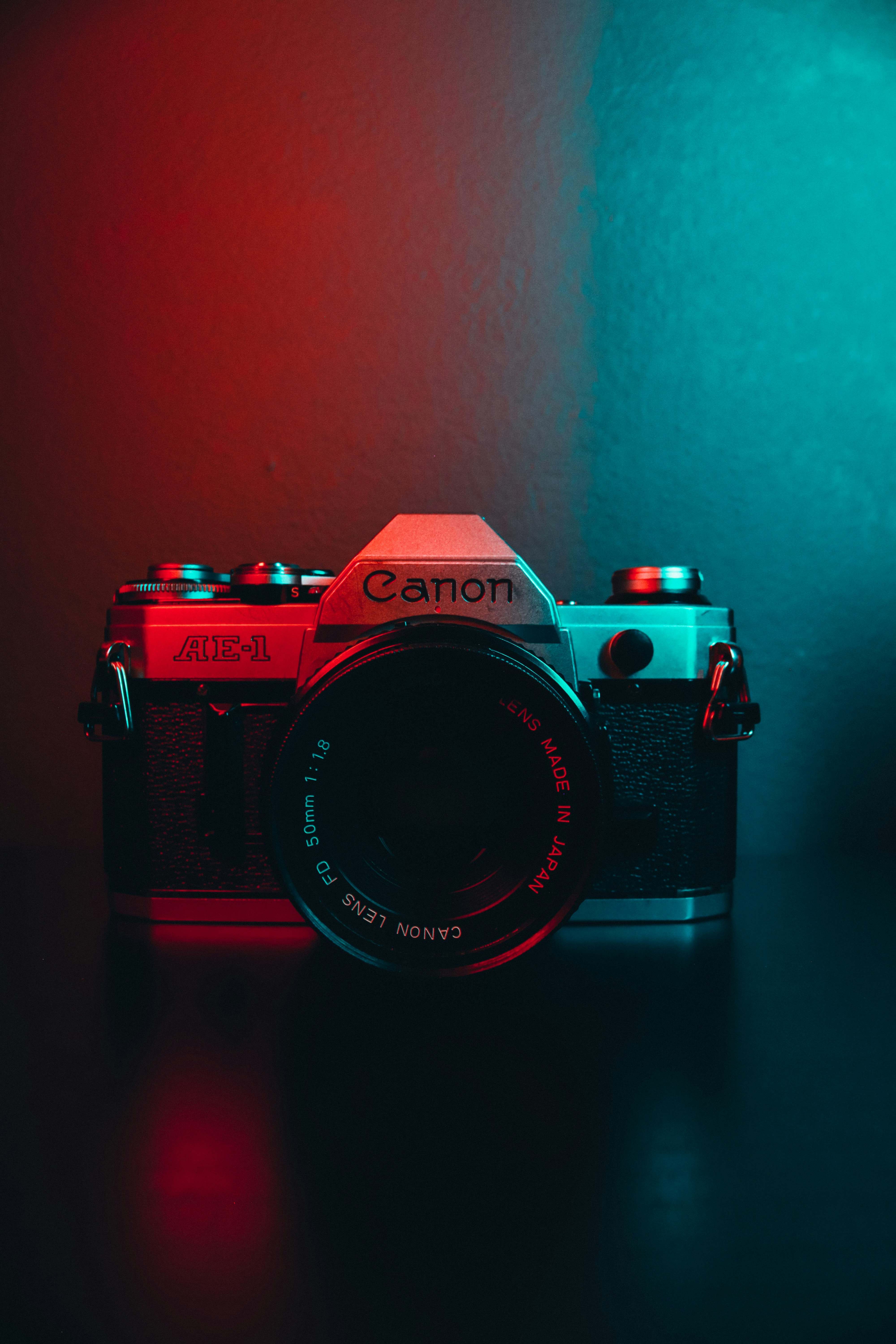 A red and blue camera sitting on top of a table photo – Free Dark Image ...