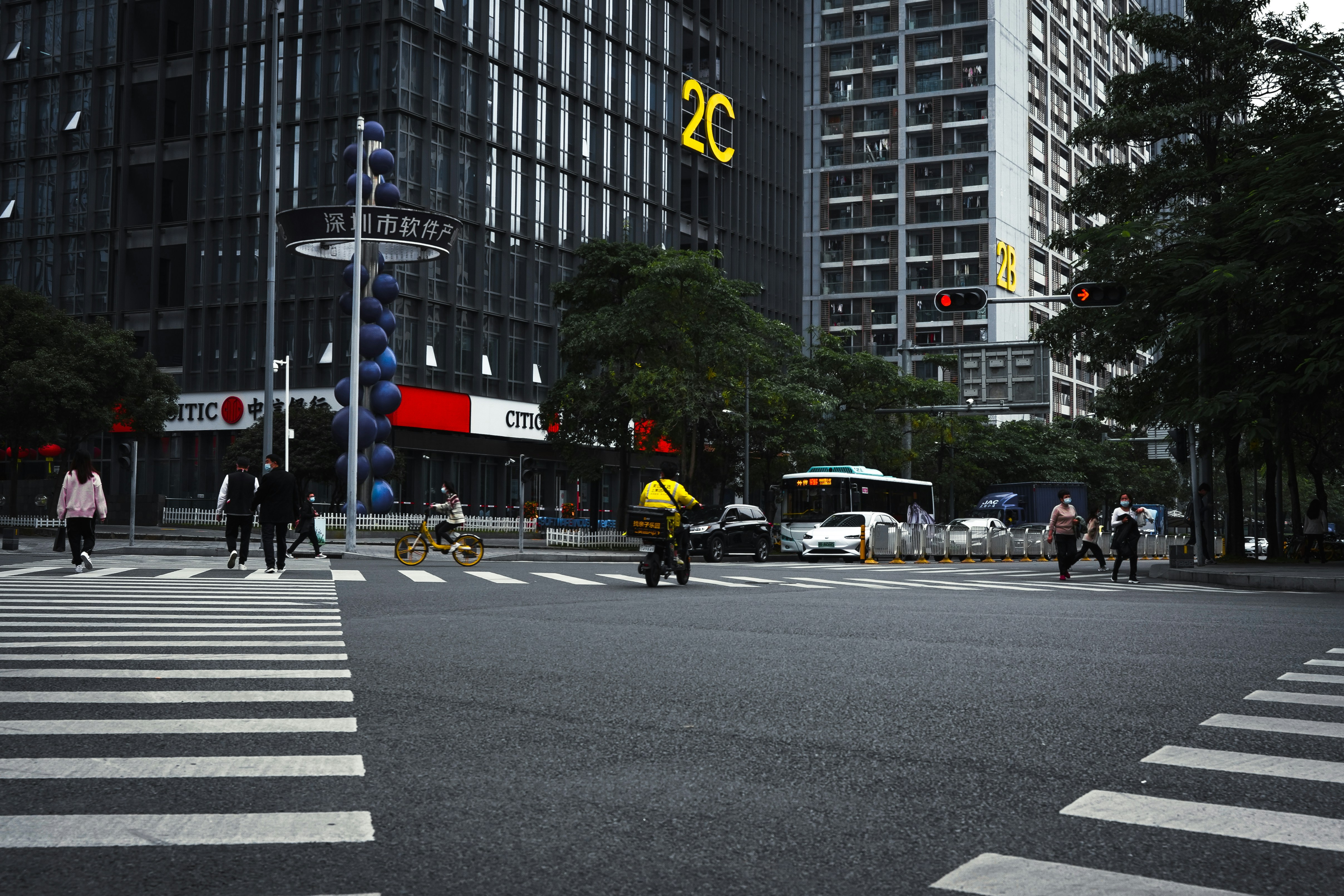 A city intersection with people crossing the street photo – Free ...