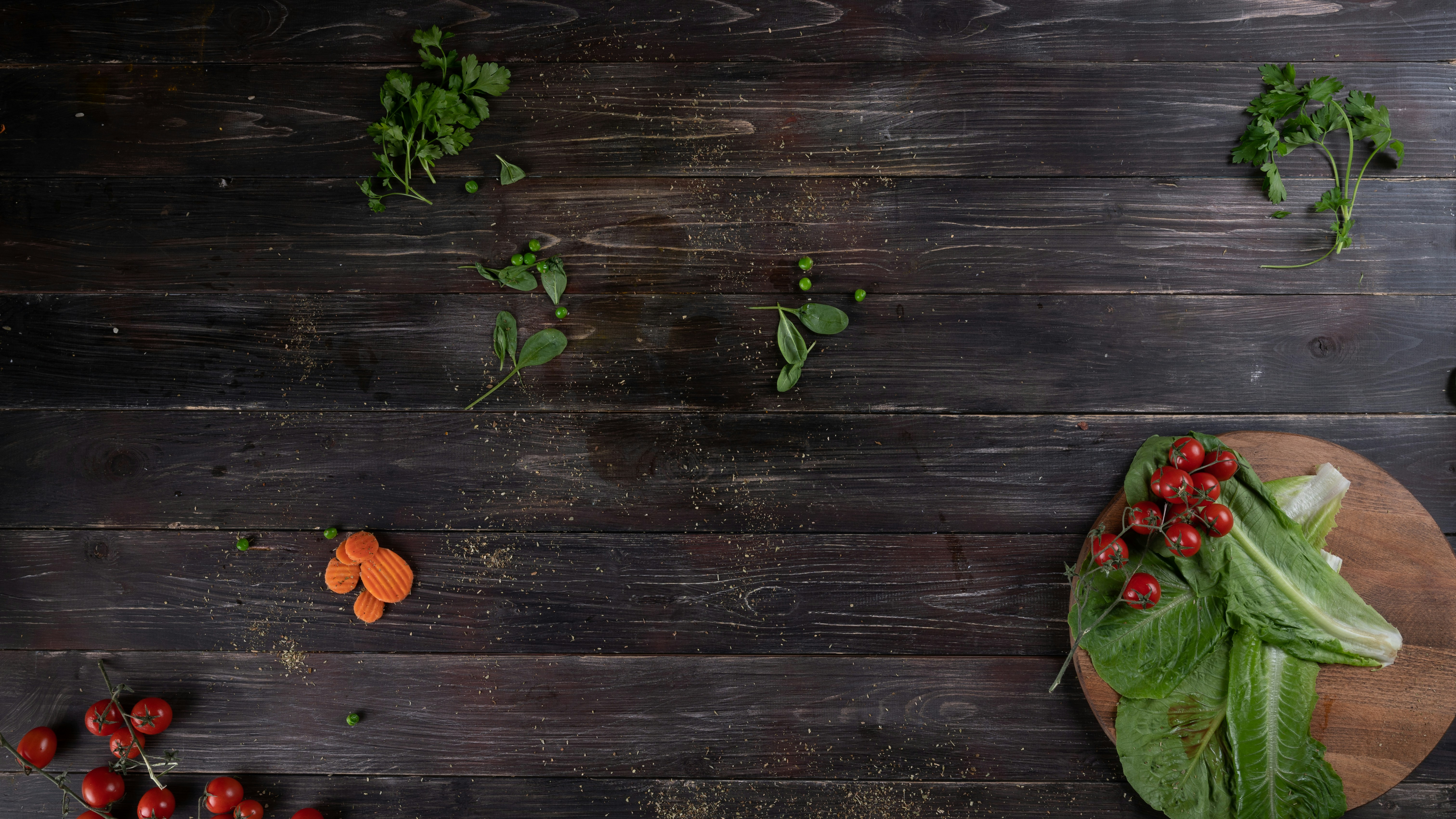 Fresh vegetables and herbs arranged artistically on a rustic wooden surface, highlighting the beauty of natural ingredients.