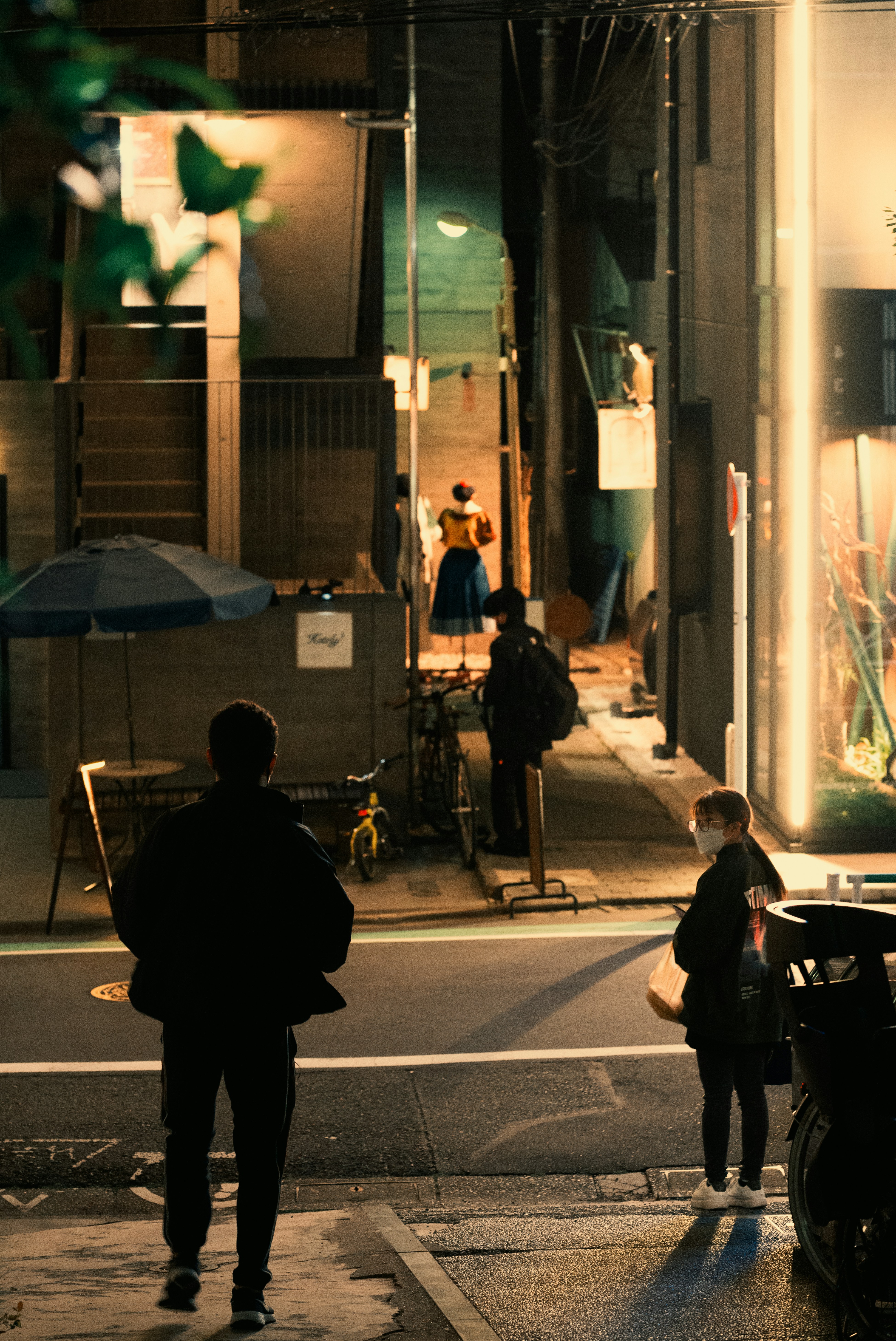Blue-dressed silhouette amid neon whispers in a city alley
