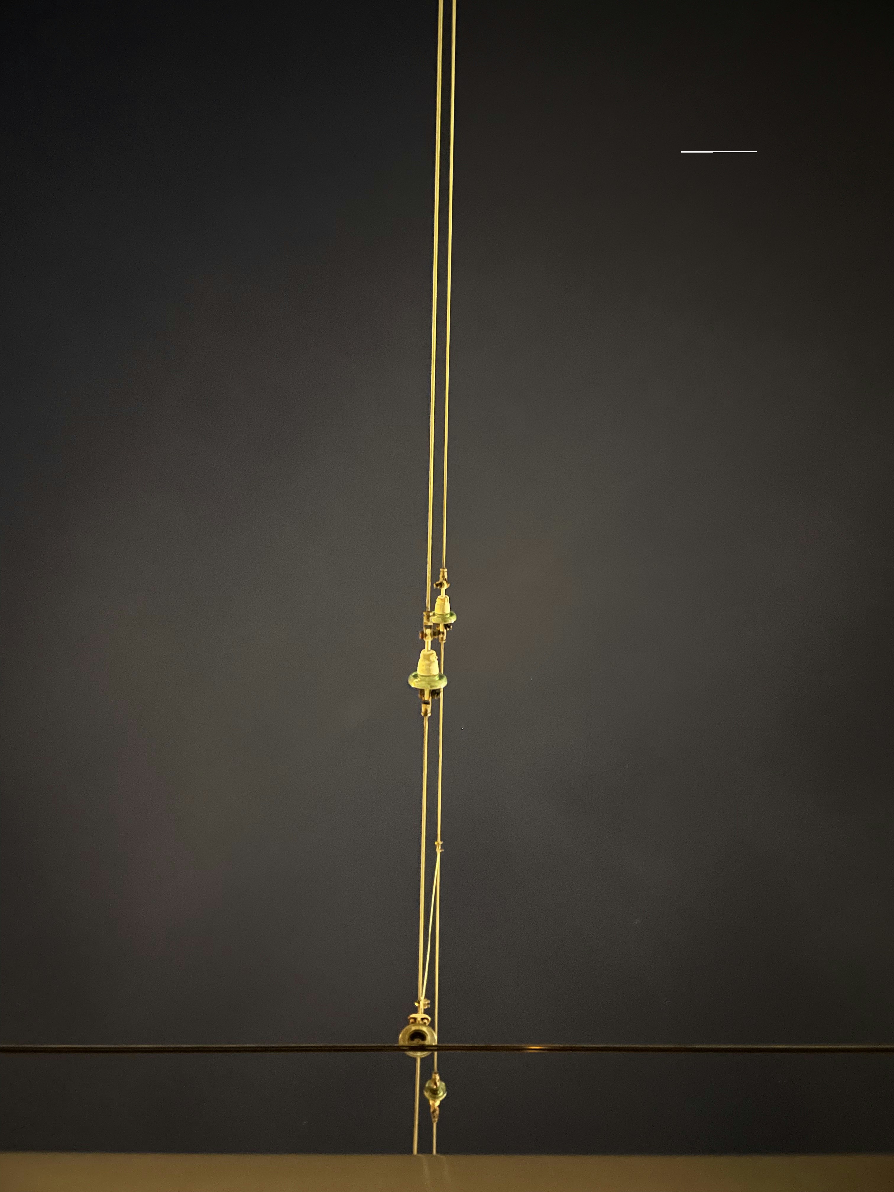 A tall gold pole with two bells hanging from it photo – Free France ...