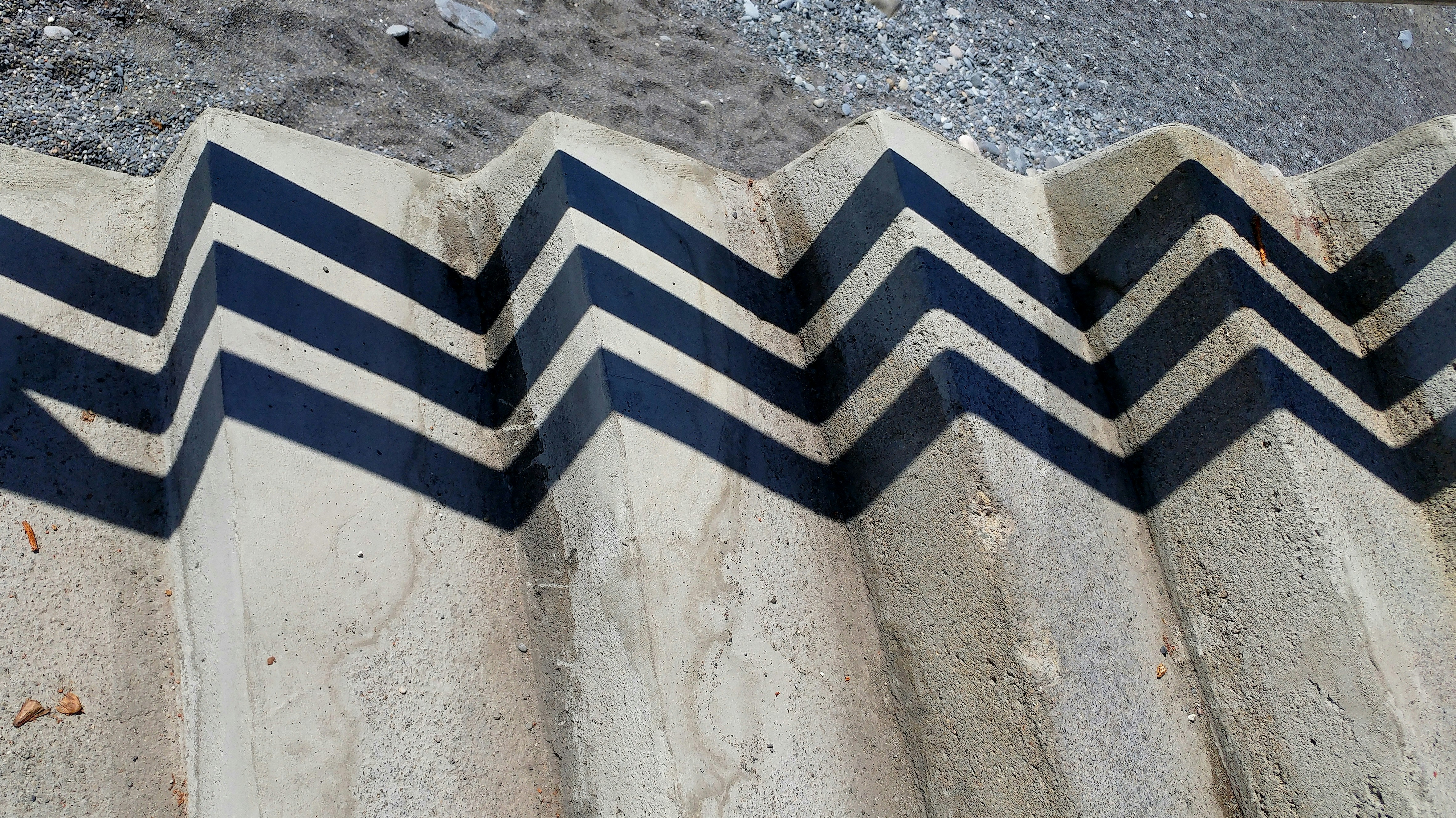 A close up of a cement wall with a chevron pattern photo – Free Texture ...