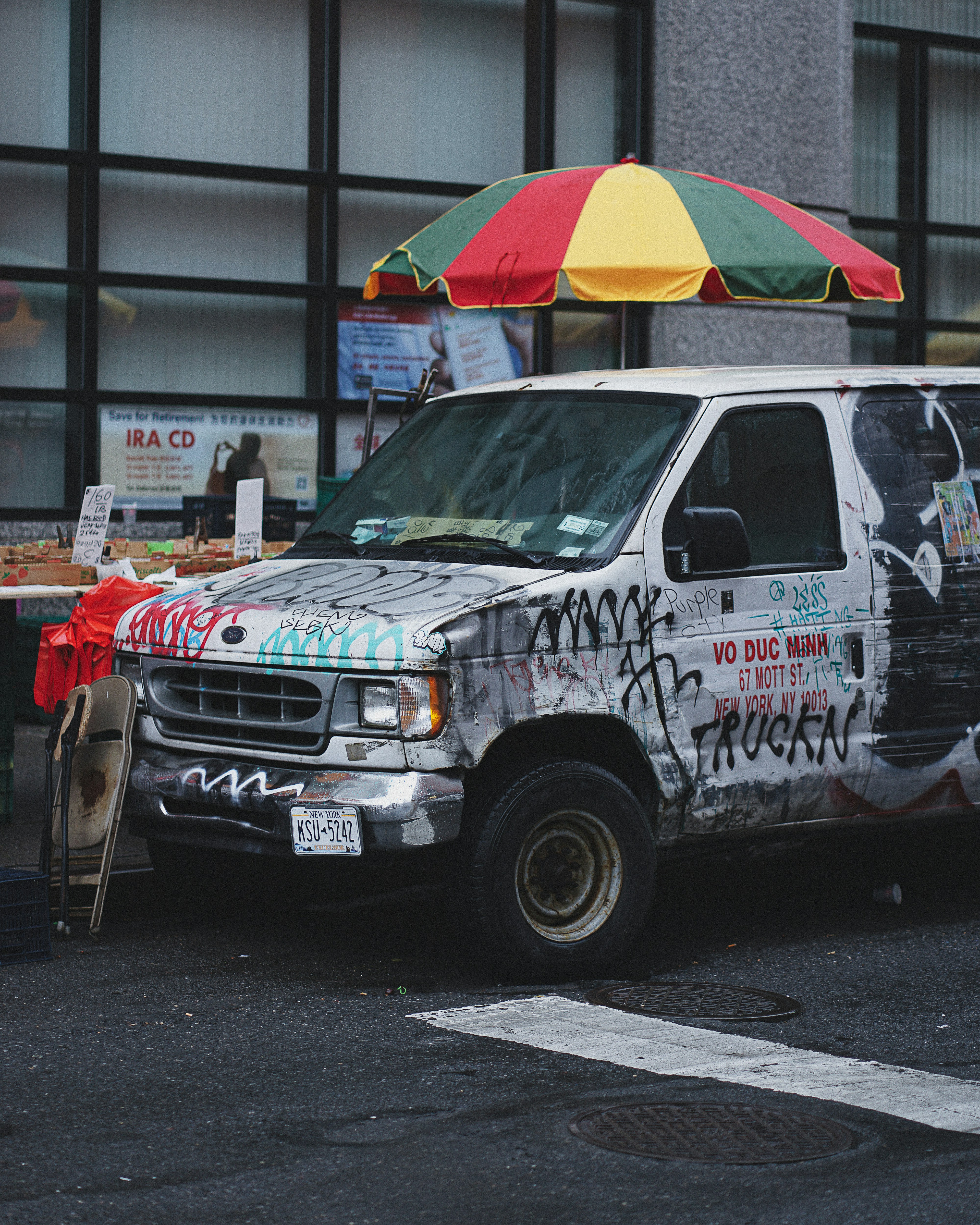 a van with graffiti on it parked in front of a building