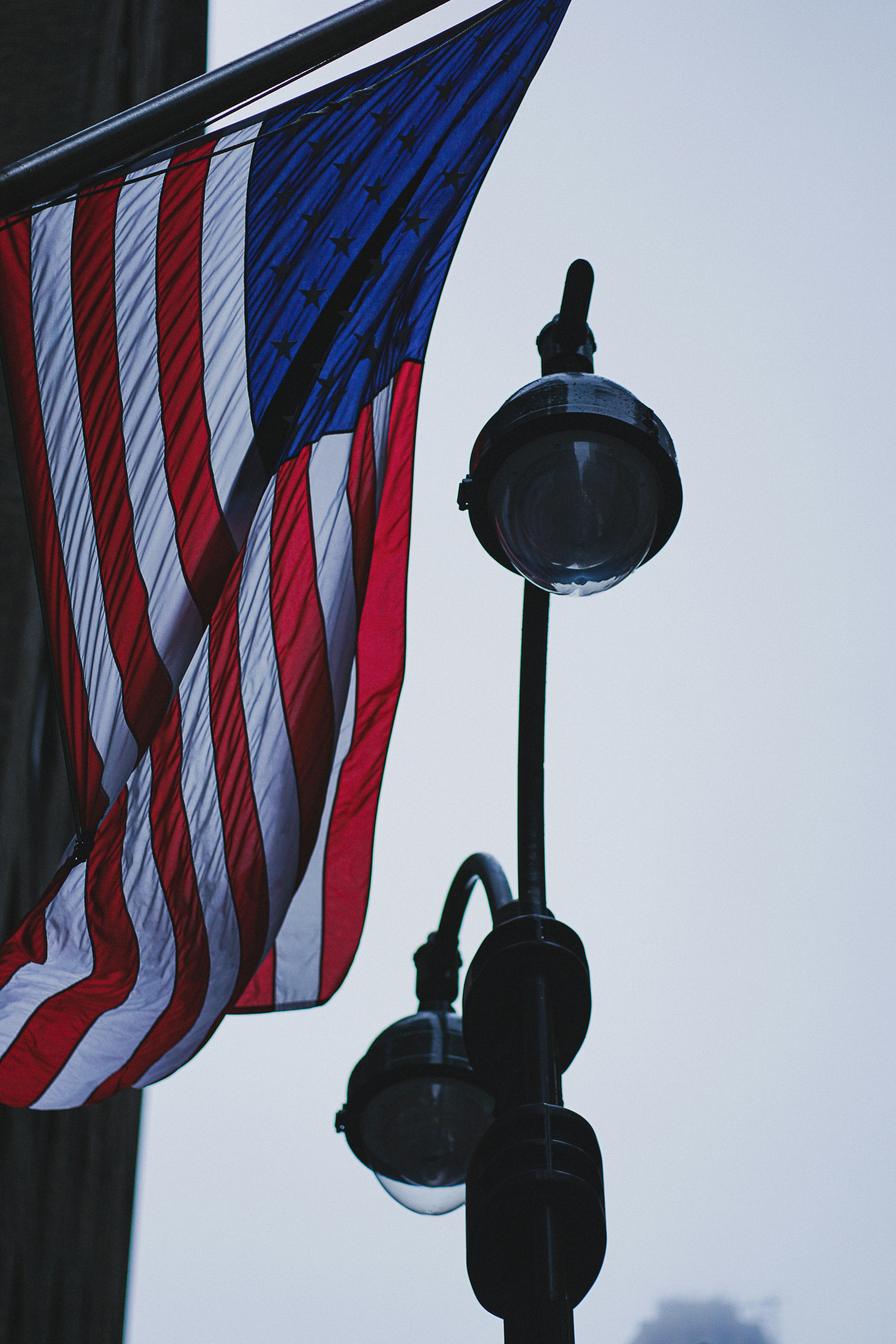 Flag and Lamps: A Quiet Urban Moment in Blue Hour