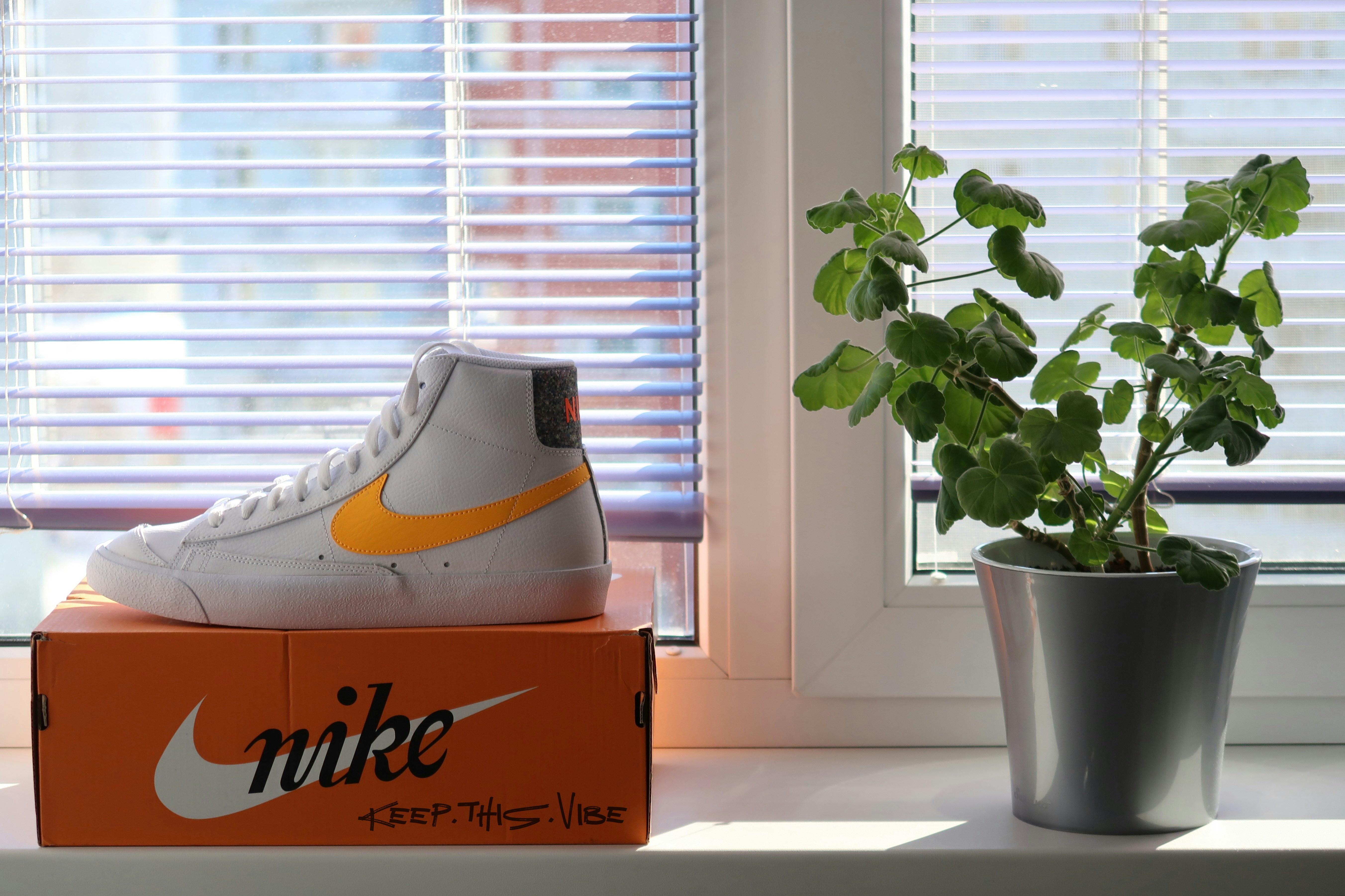 a pair of nike shoes sitting on top of a box