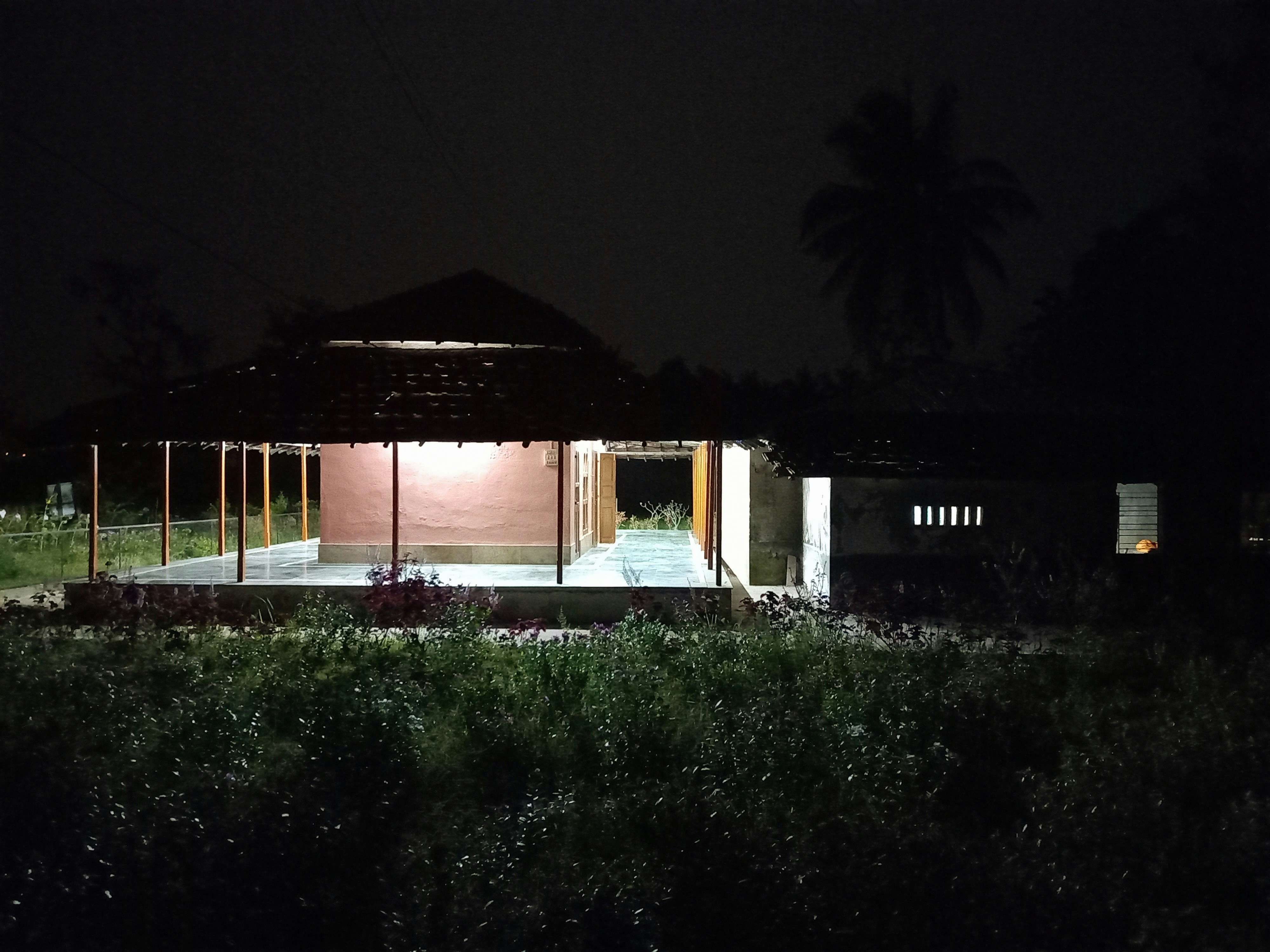 A hut on the Banks of Hooghly River | a gazebo lit up at night in a field