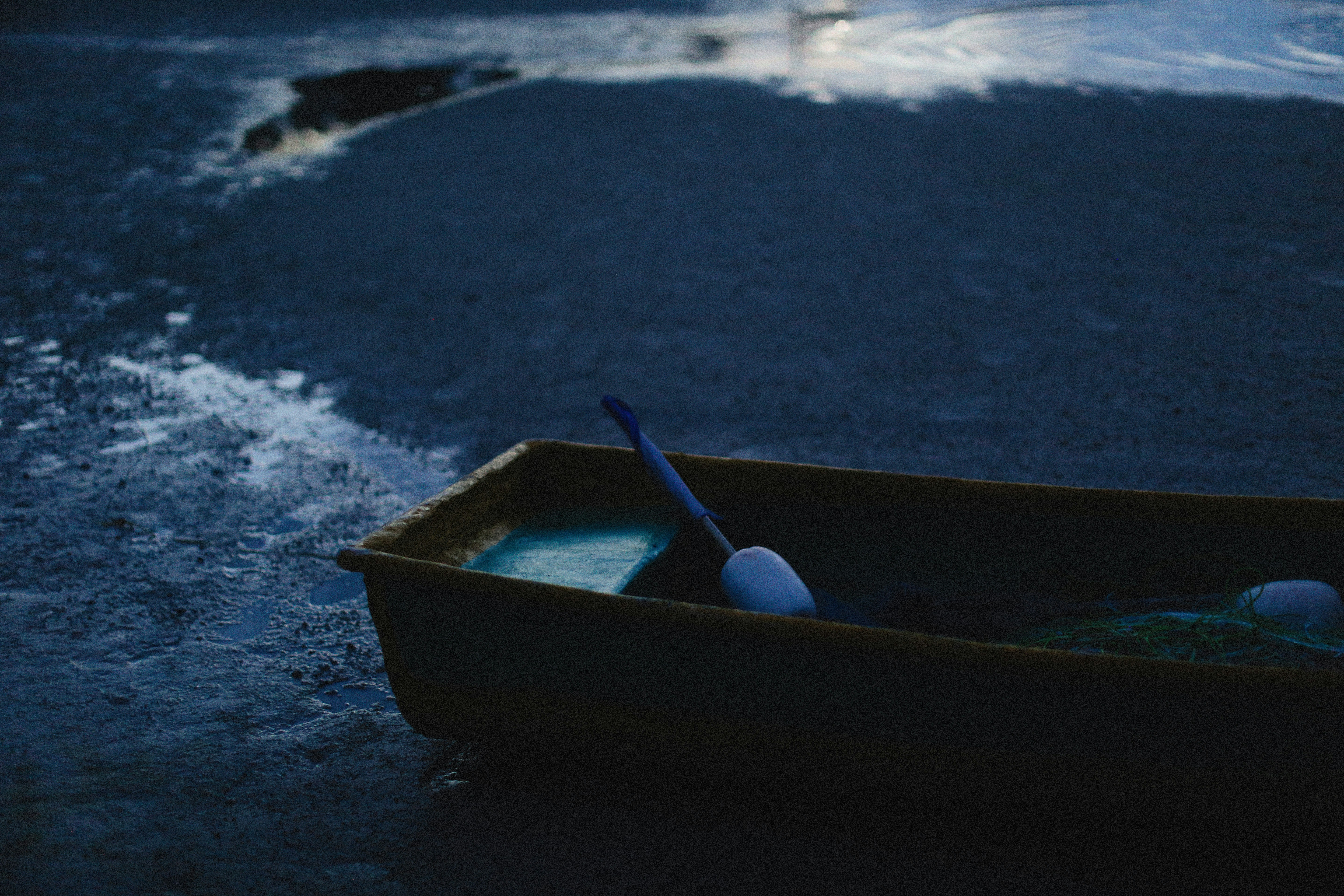 Blue Tray on Frost: A Paddle Resting on the Ice
