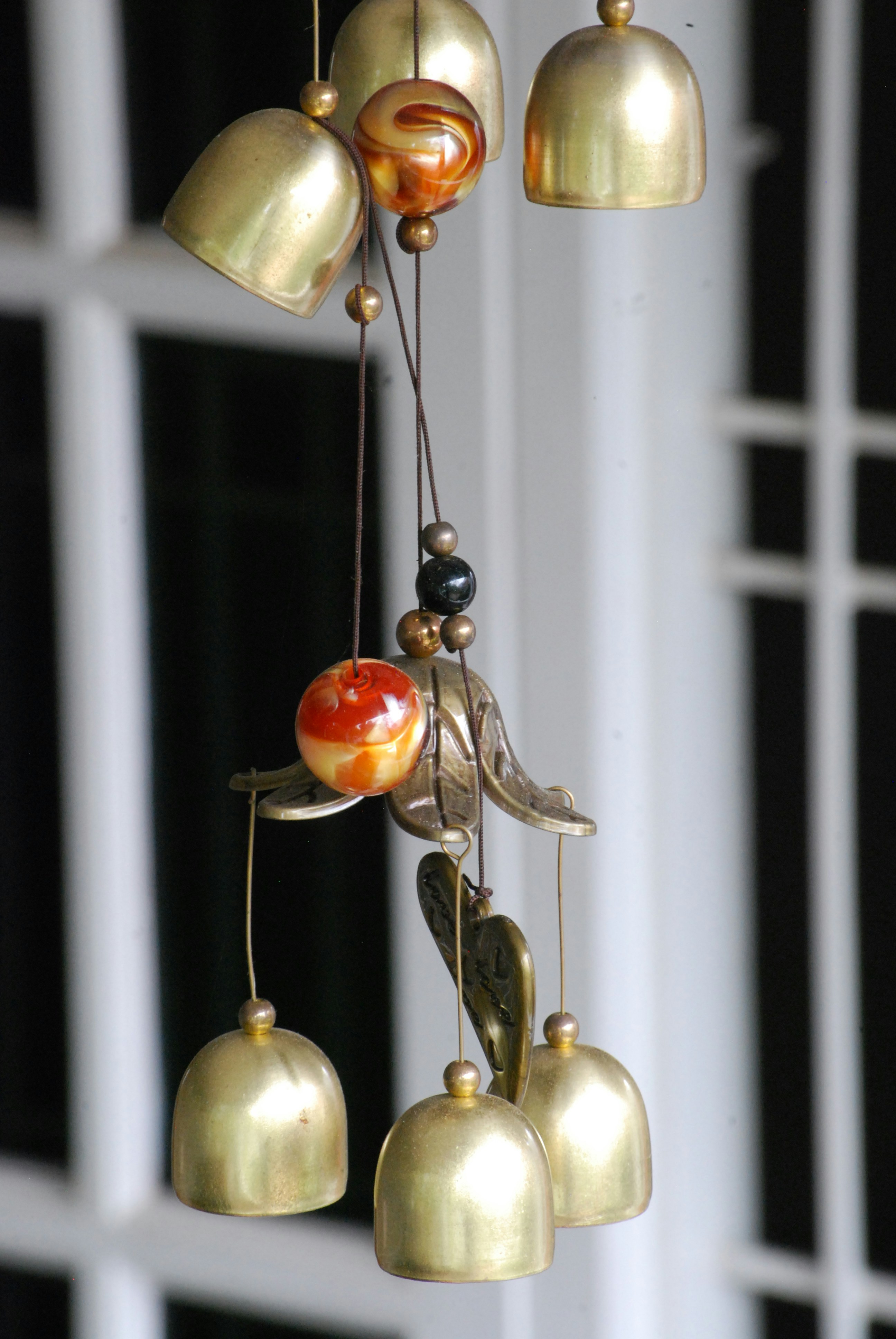 Brass Wind Chimes and Marble Orbs: A Quiet Window-Side Still-Life