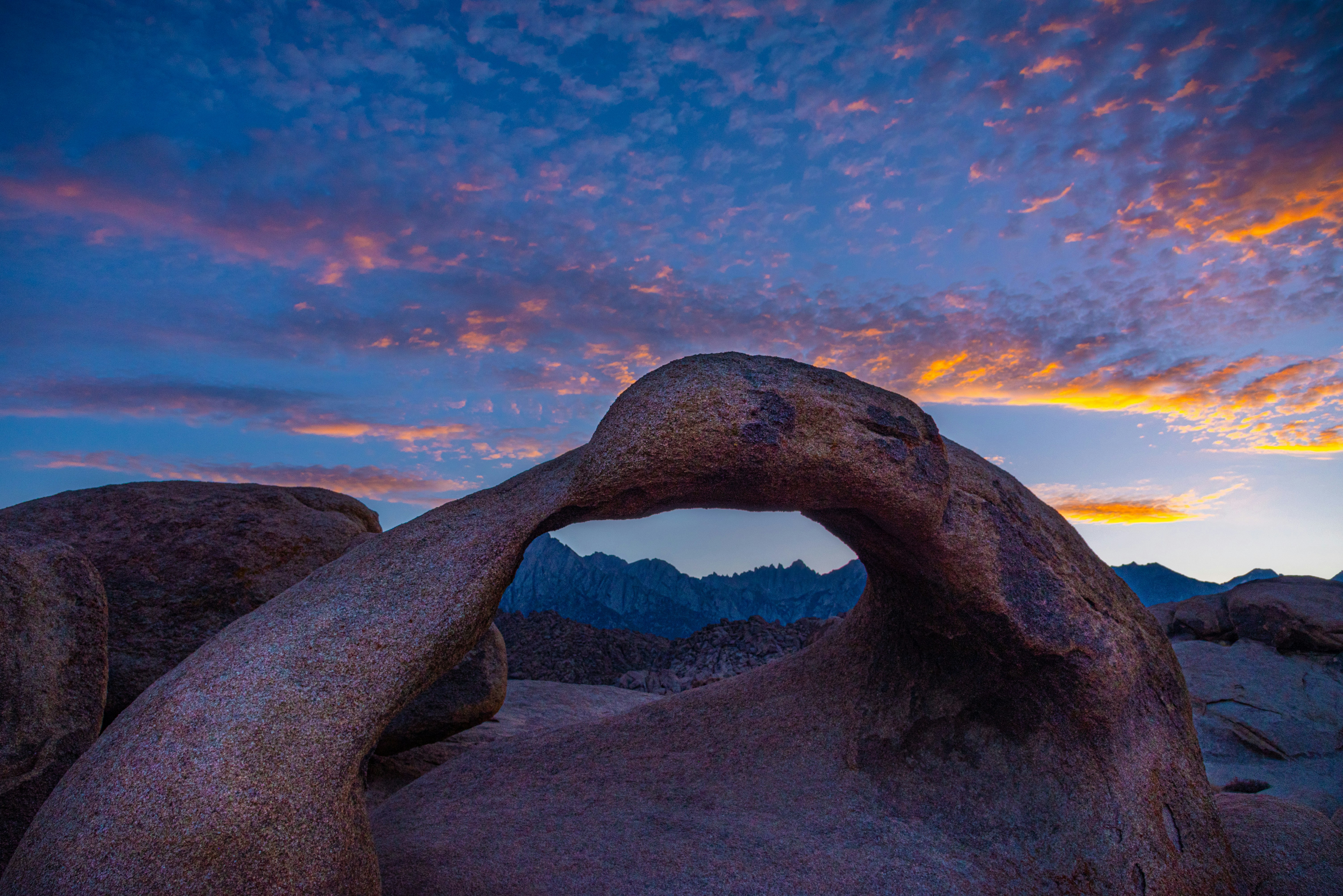 Archway at Twilight: A Granite Ring Framing the Distant Range