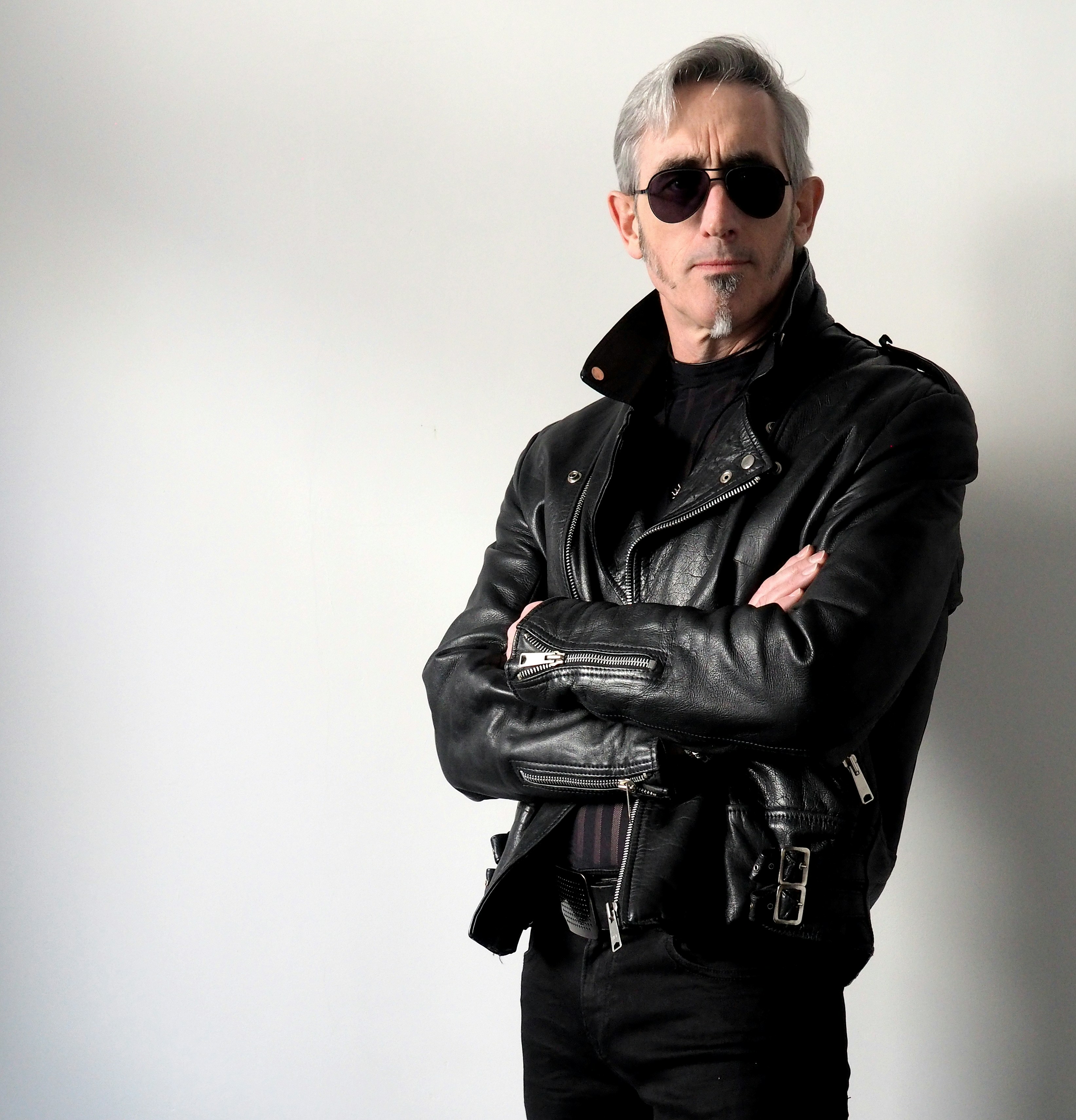 Senior male model wearing leather jacket and dark glasses