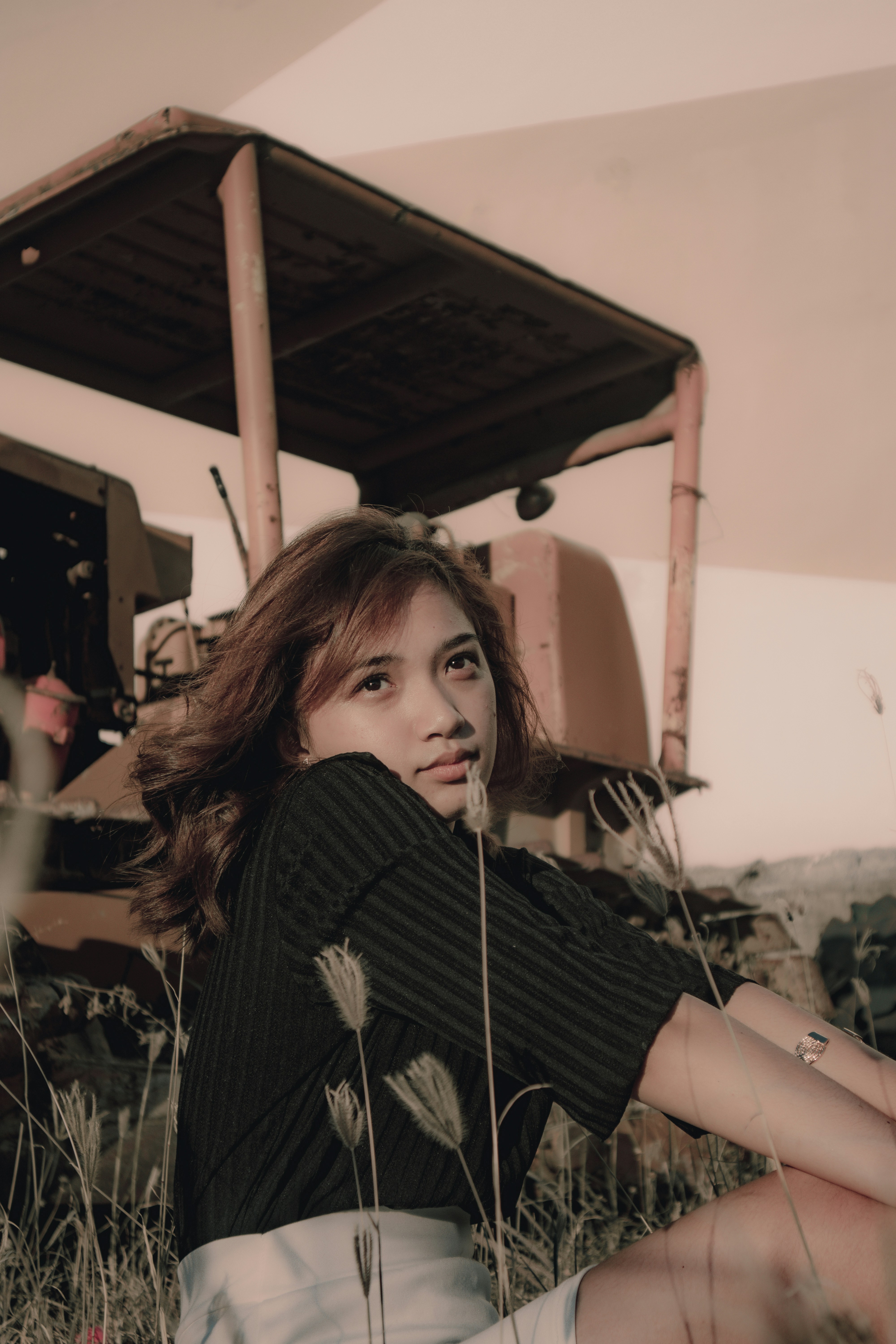 Portrait in a Quiet Field: The Gaze Amid Industrial Backdrops