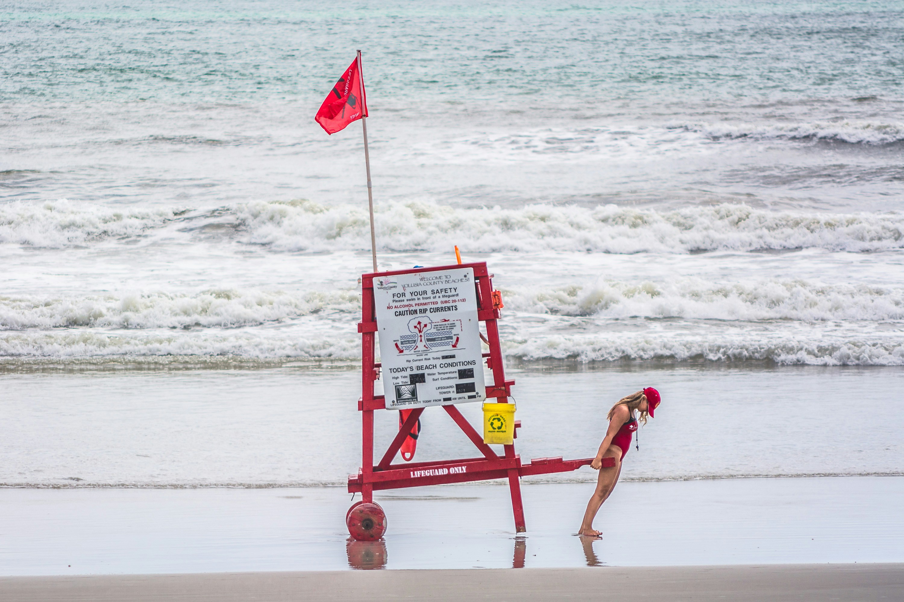 Crimson Lifeguard Chair Framing a Quiet Beach Moment