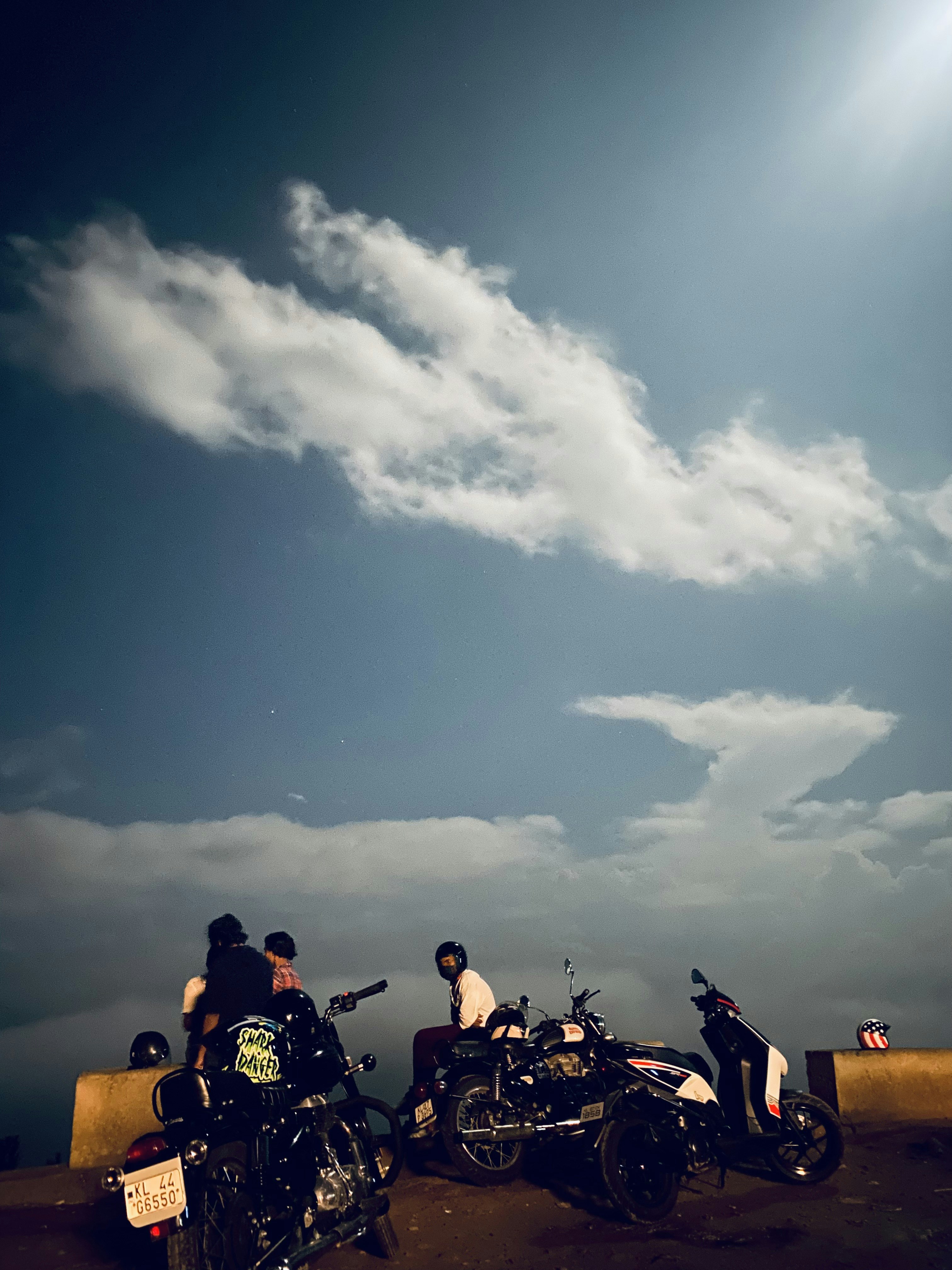 A group of motorcycles parked on a dirt road photo – Free Grey Image on ...