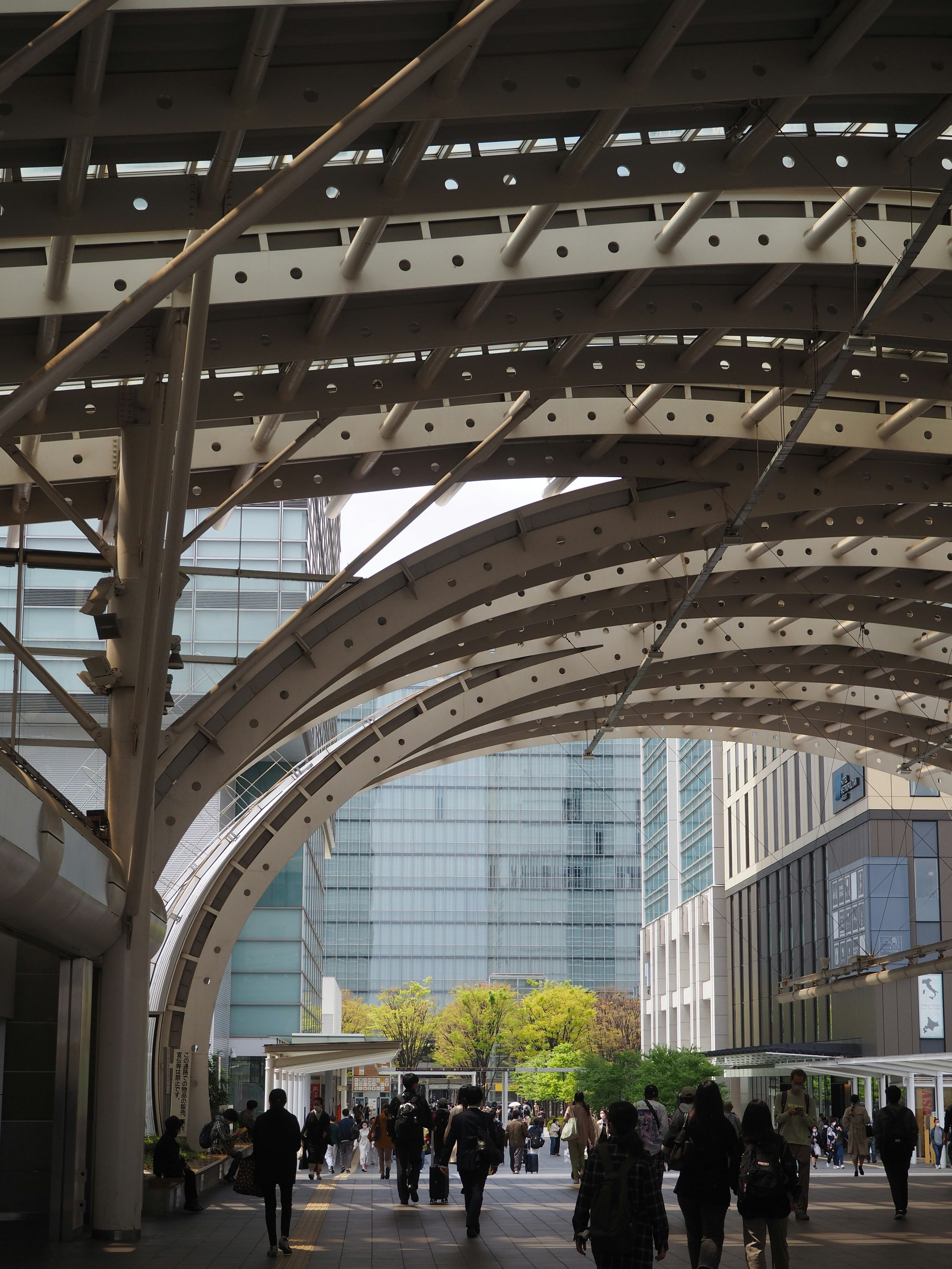 A group of people walking inside a building photo – Free Grey Image on ...