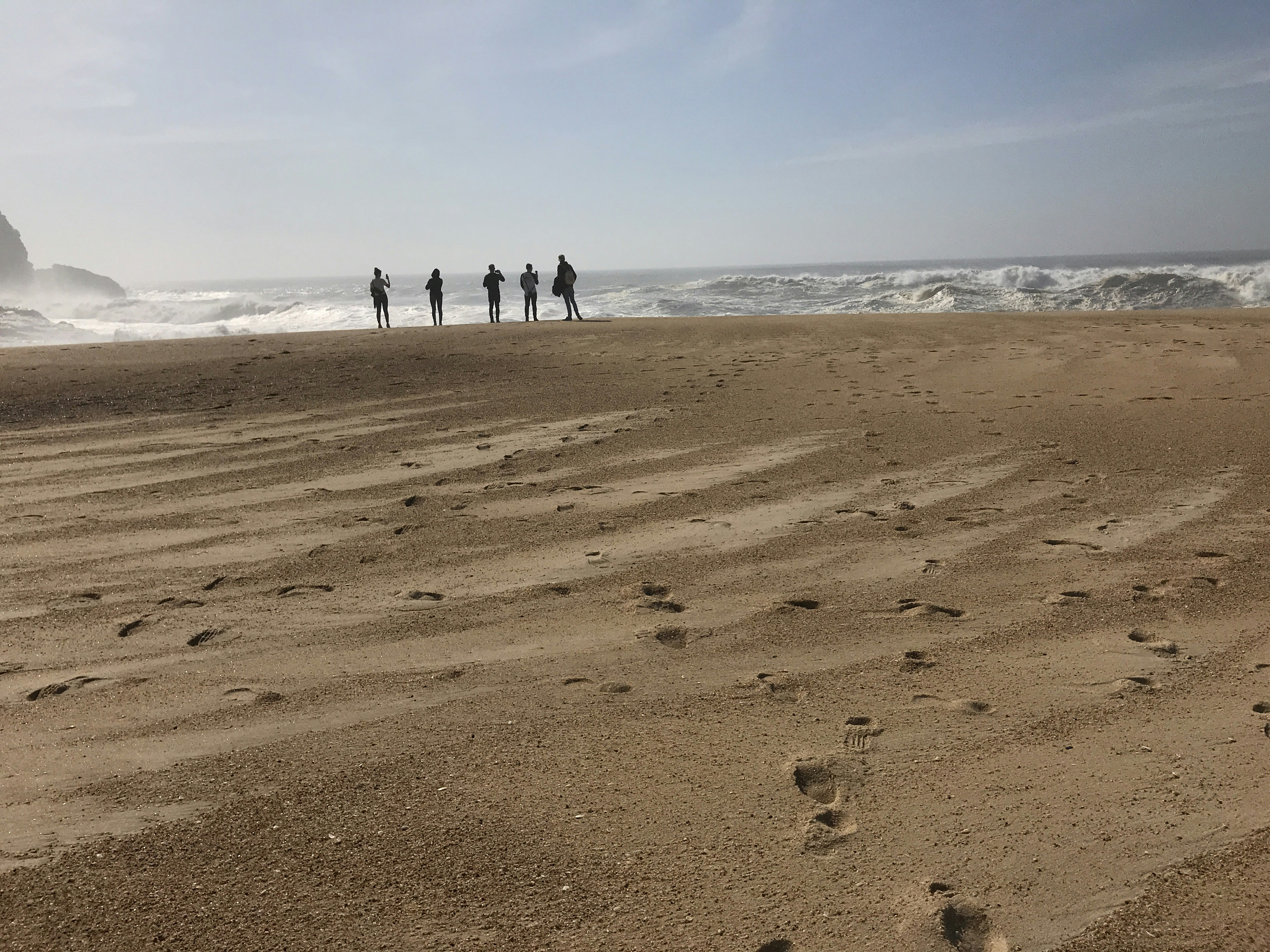 Five Silhouettes at the Quiet Edge of the Surf