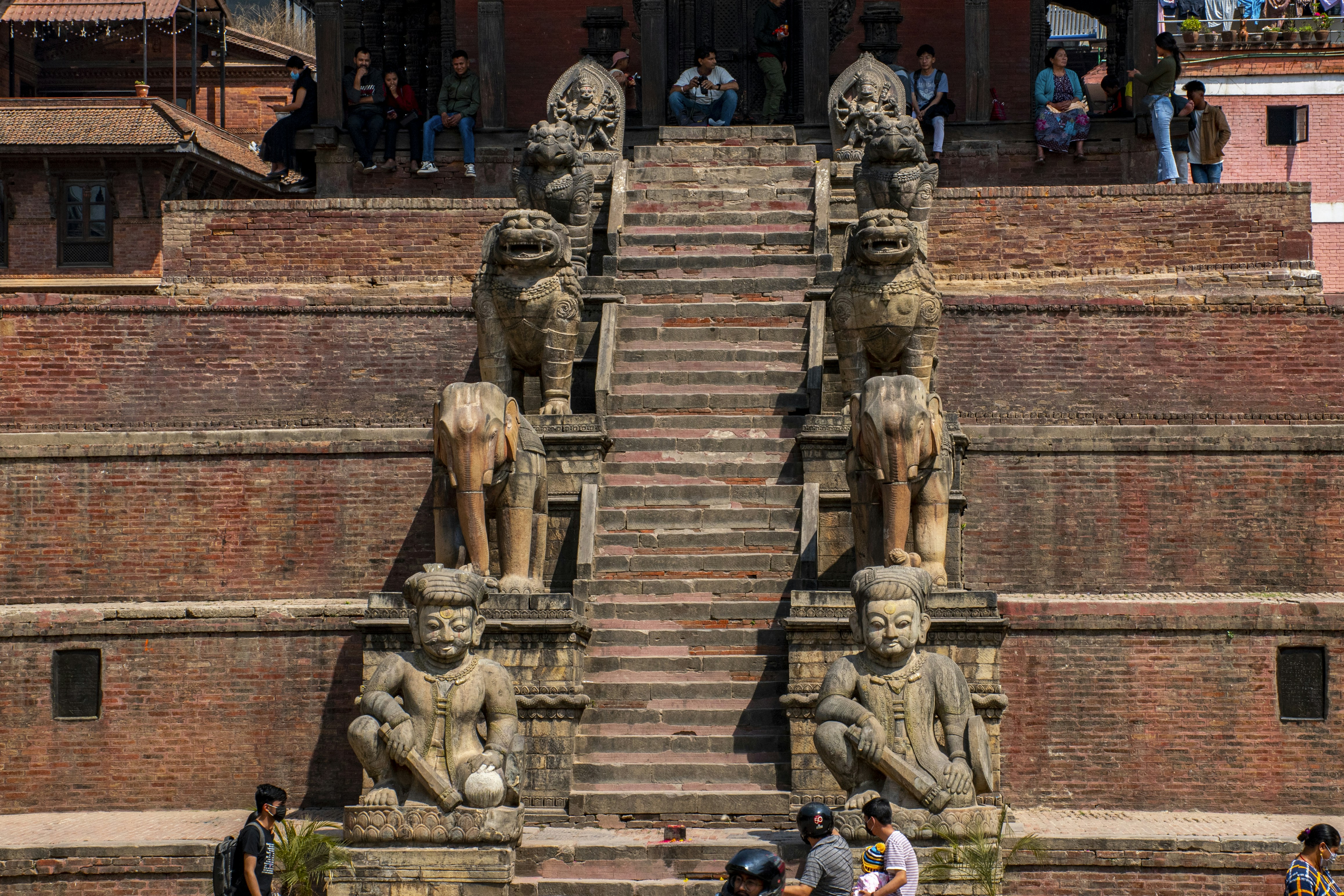 A group of statues on a brick building photo – Free Bhaktapur Image on ...