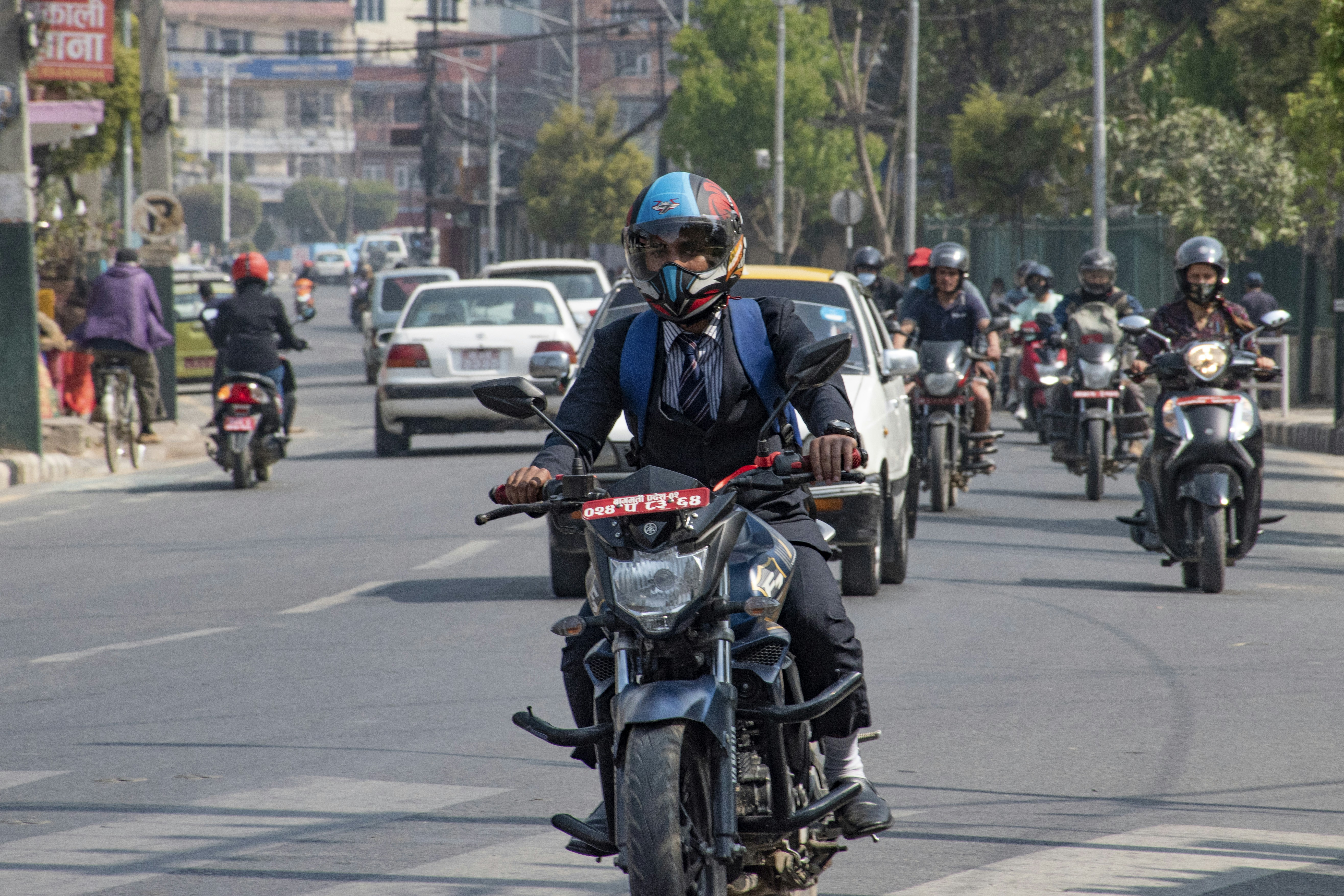 A group of people ride motorcycles down a street photo – Free Kathmandu ...