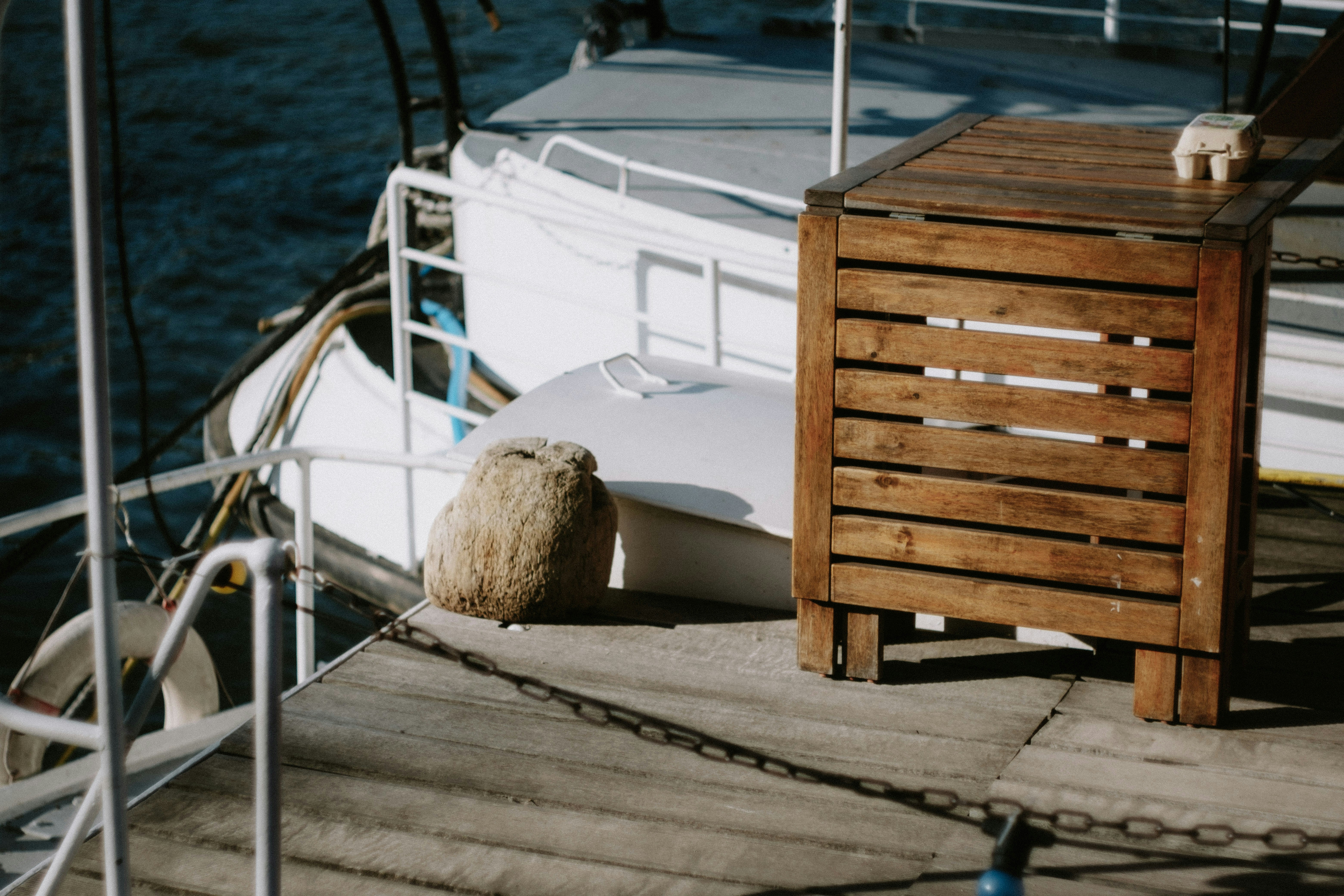 Quai-side Slatted Chest Anchored by a Sunlit Dock