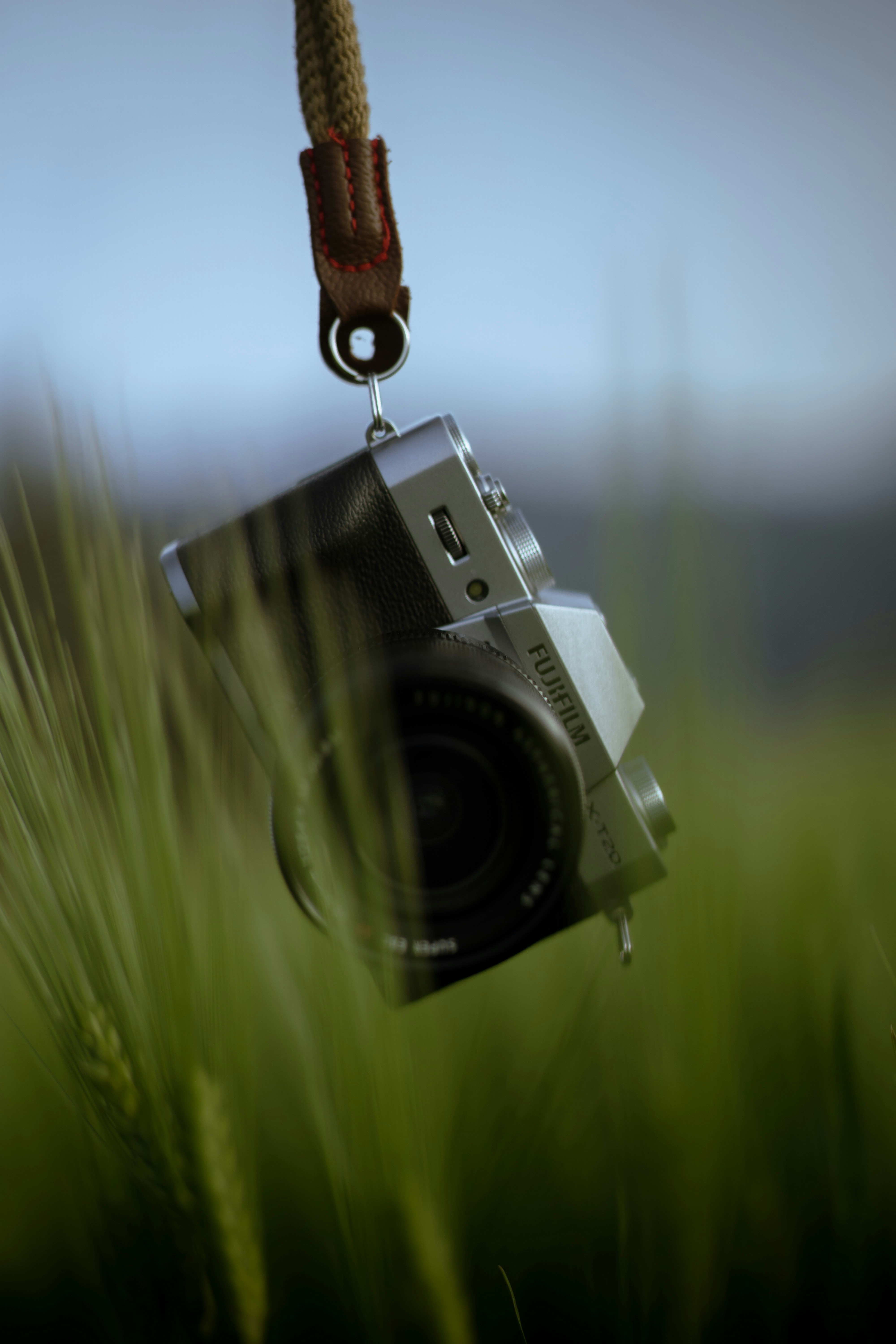 Suspended in Green: A Fujifilm Camera Dangles Over the Grass