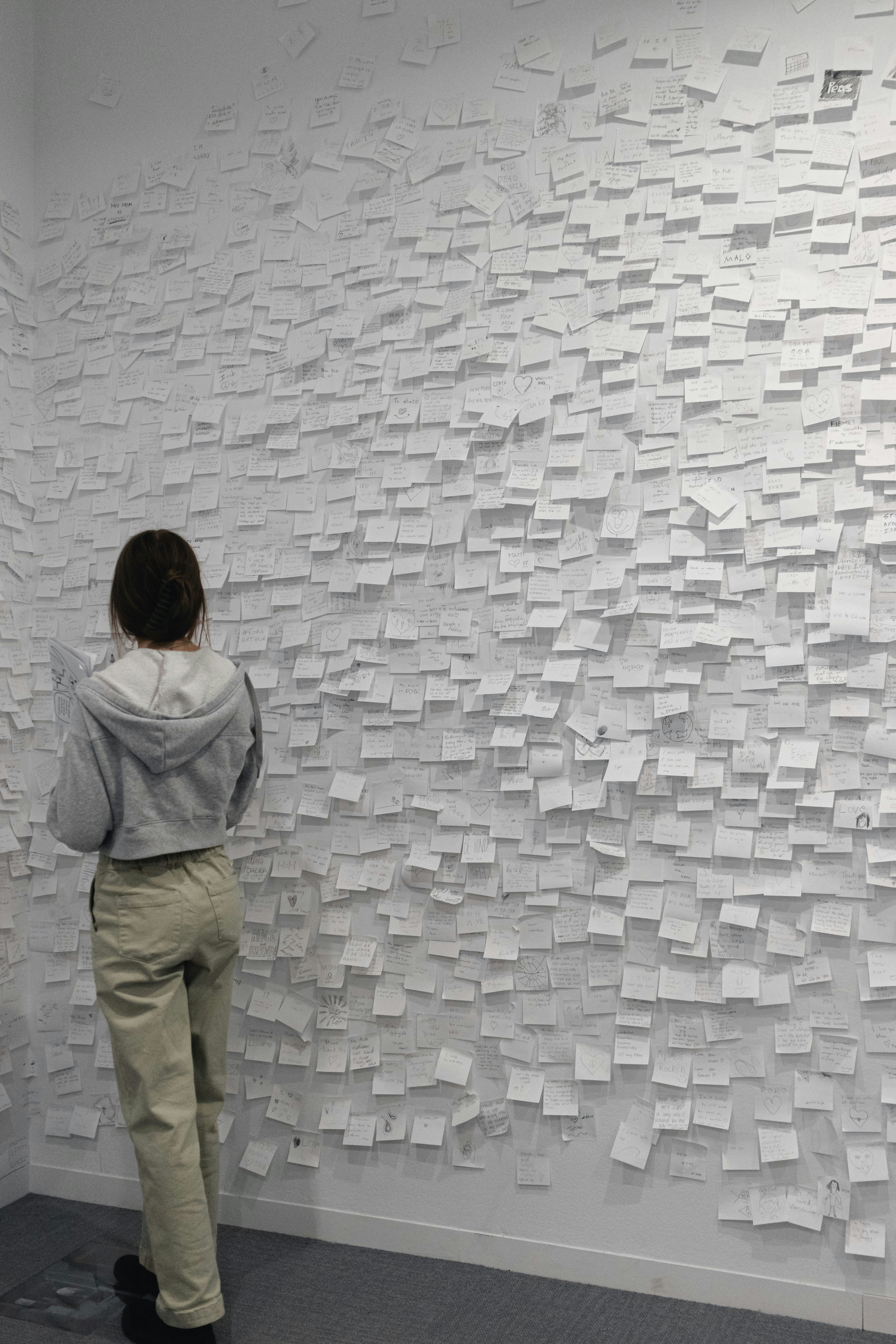 A person looking at a wall of paper photo – Free Human Image on Unsplash