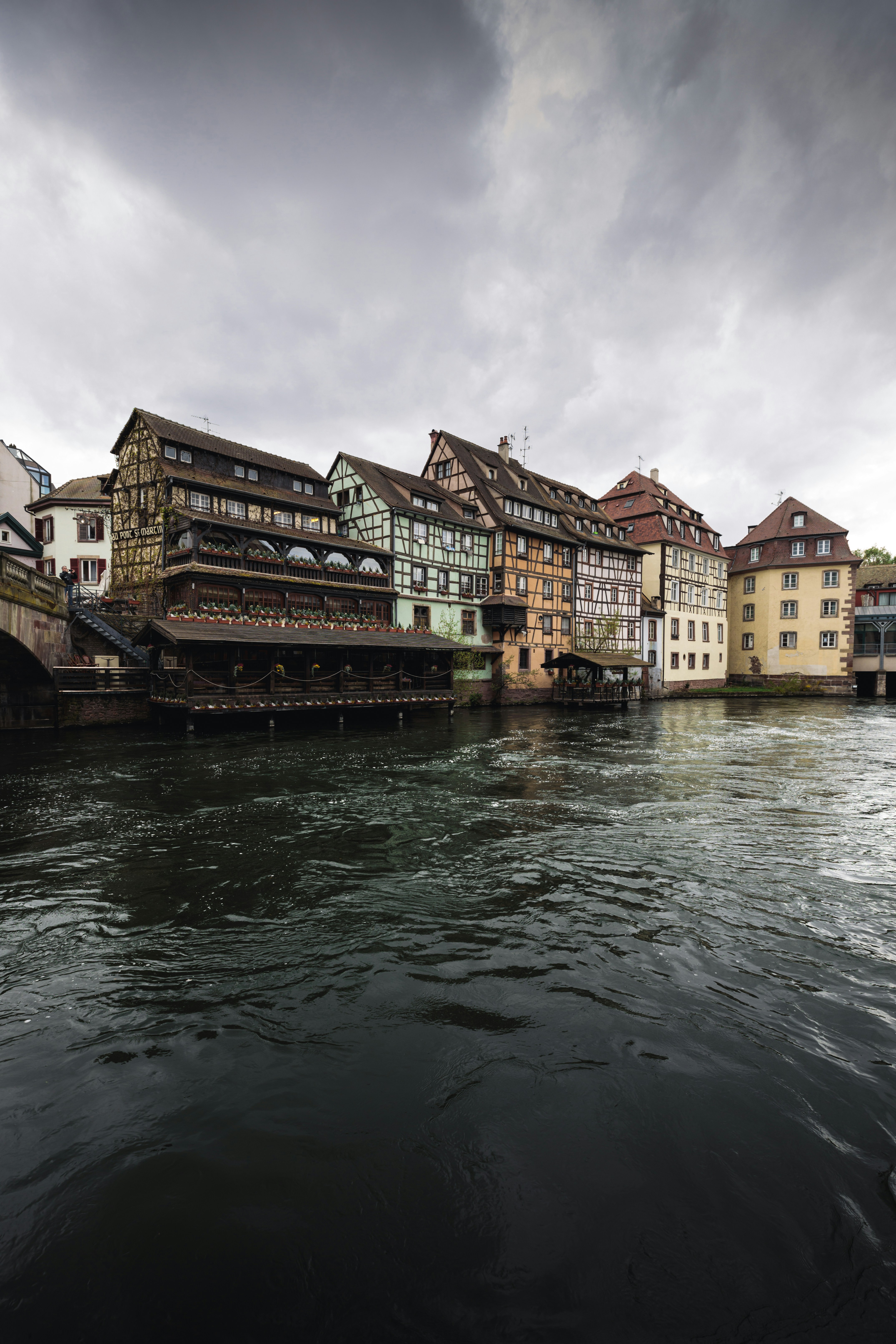 Pastel Timber-Frame Row Over a Quiet River