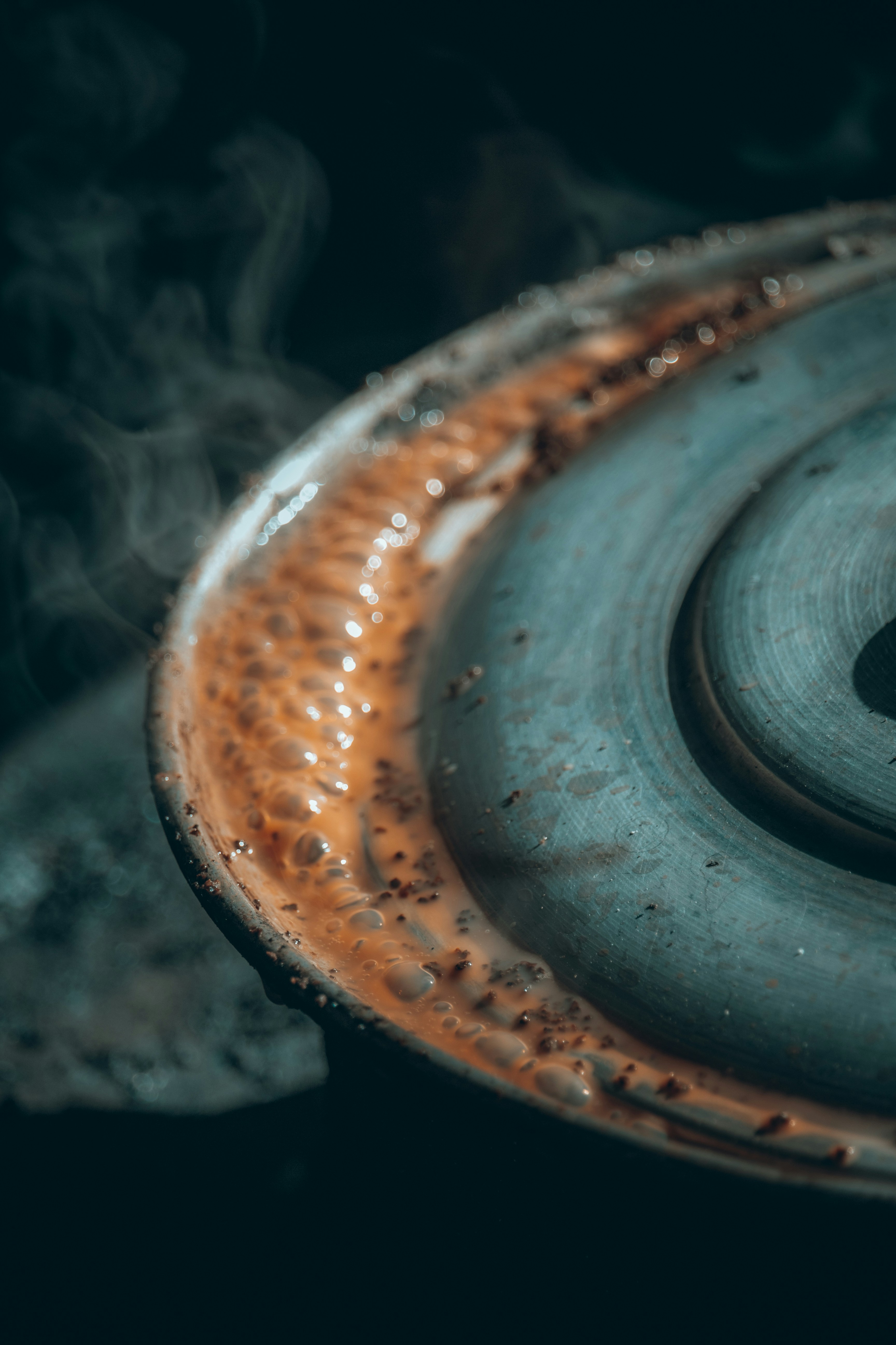 Rusted rim and glowing center: a macro glimpse into a coil of heat