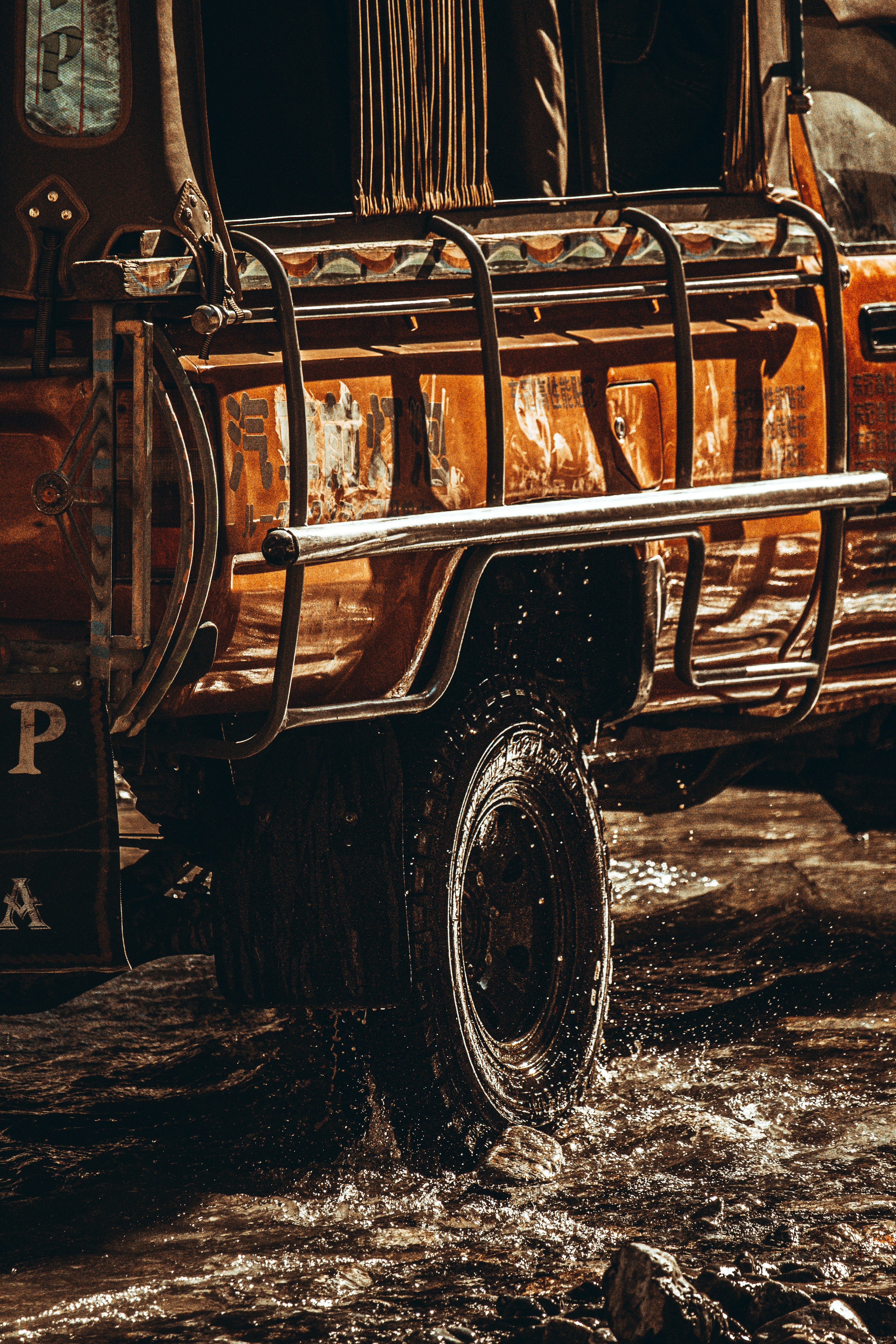 Patina at the Waterline: A Rusted Utility Vehicle Emerges from the River