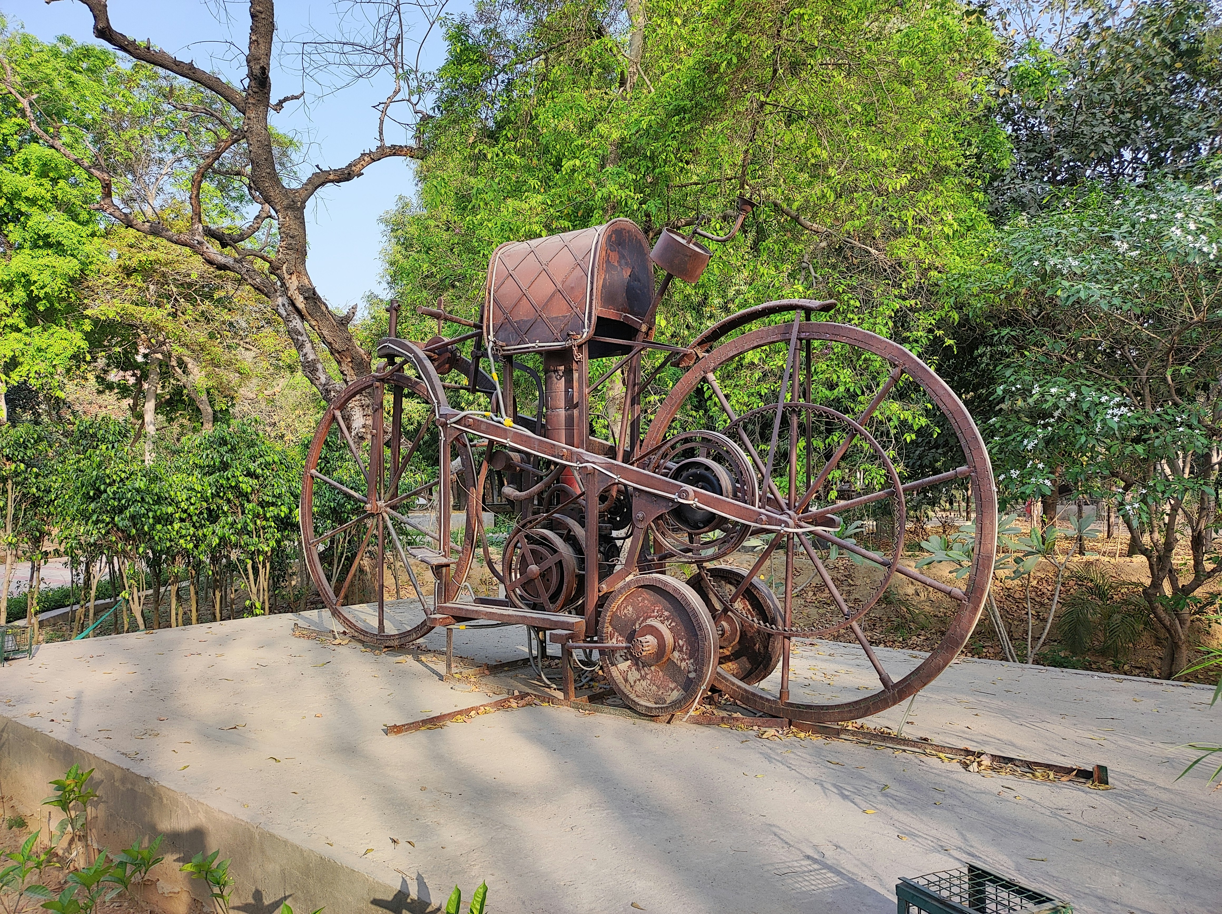 Rusty Mechanical Relic Crowned by Sunlit Foliage