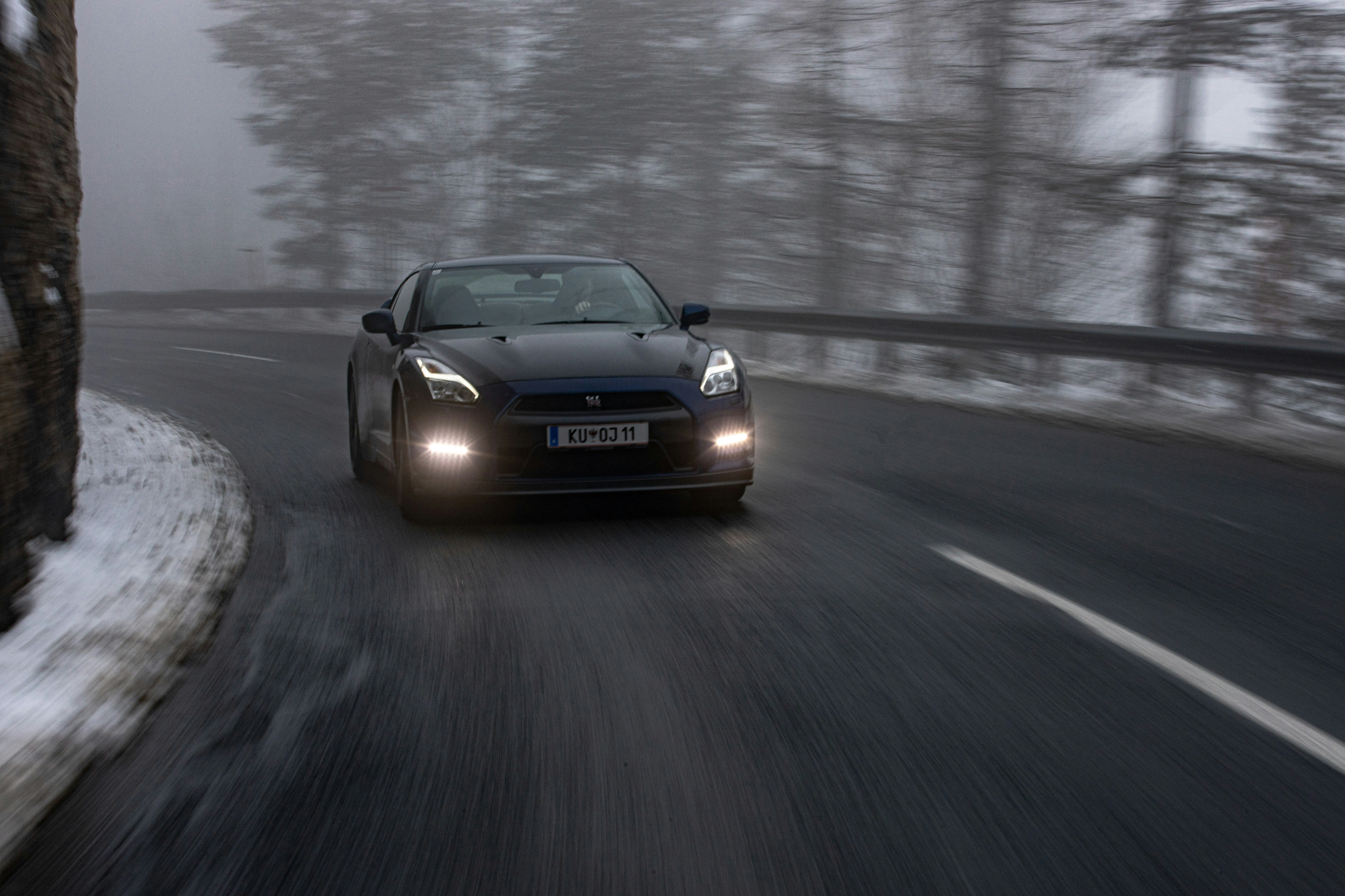 Midnight Run: A Car Rounds a Misty Alpine Curve