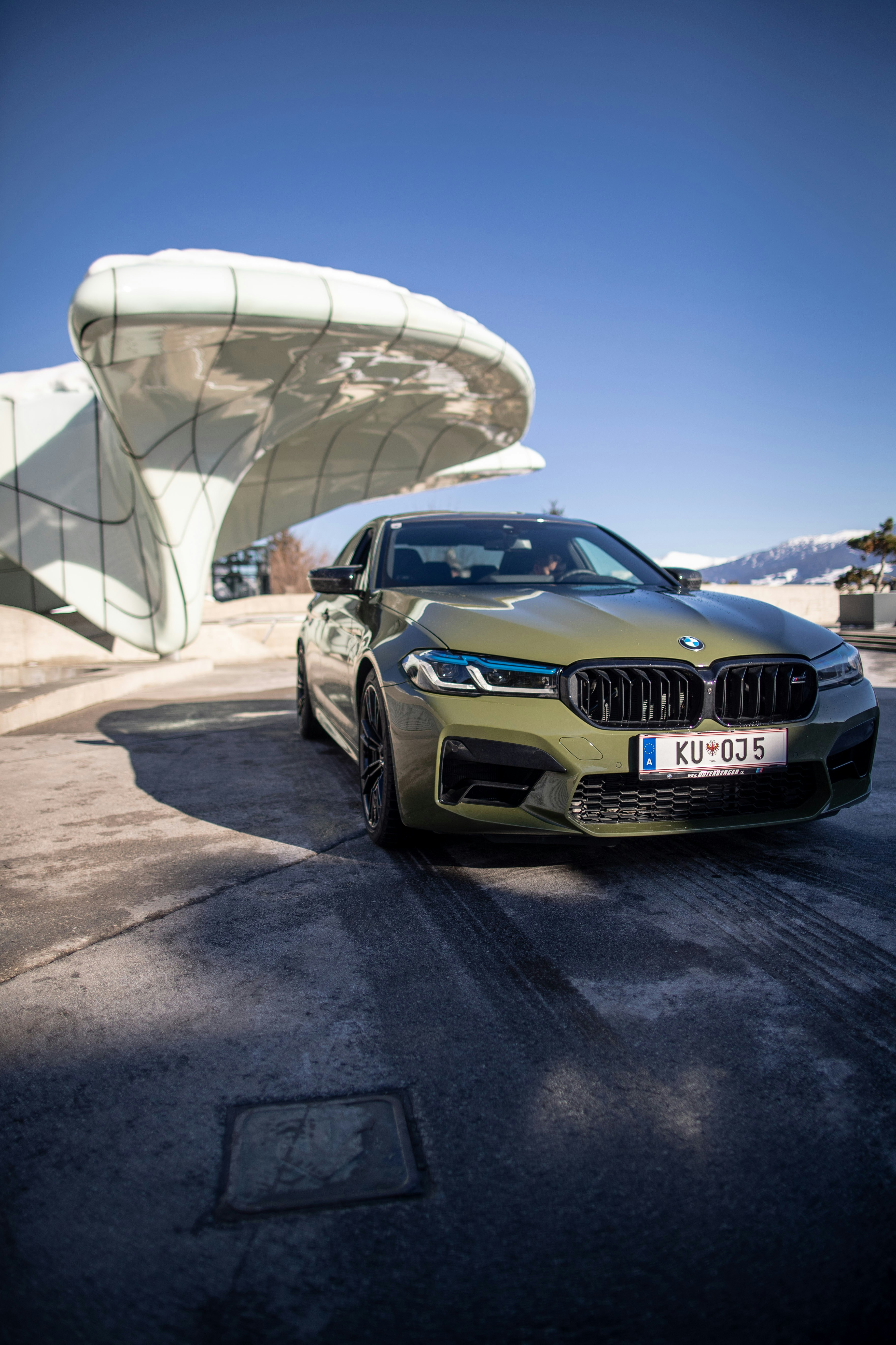 Midnight Green BMW on a Rooftop Runway Beneath a Sculptural Canopy