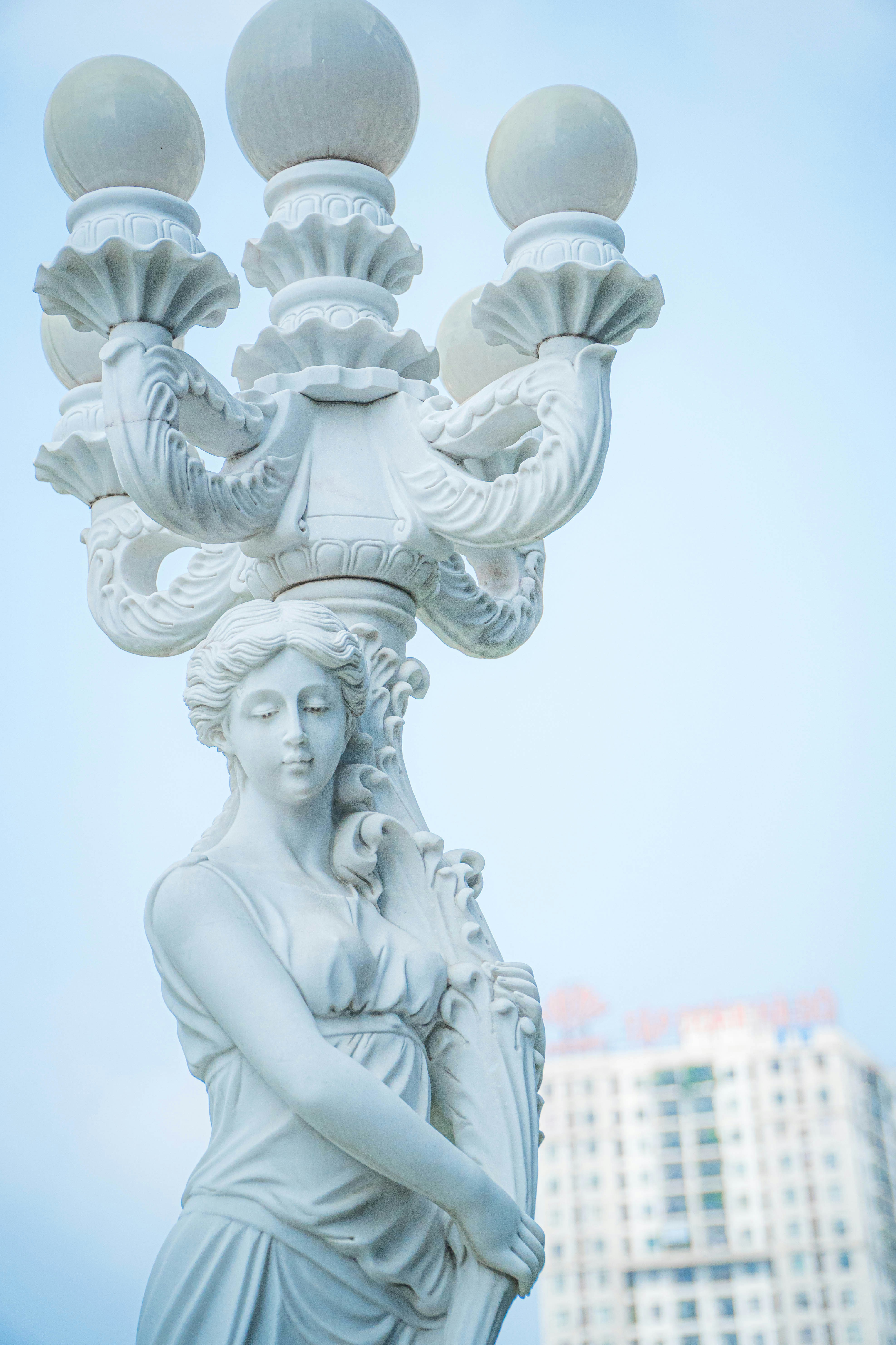 Muse Under the Lantern: White Marble Meets the City Skyline