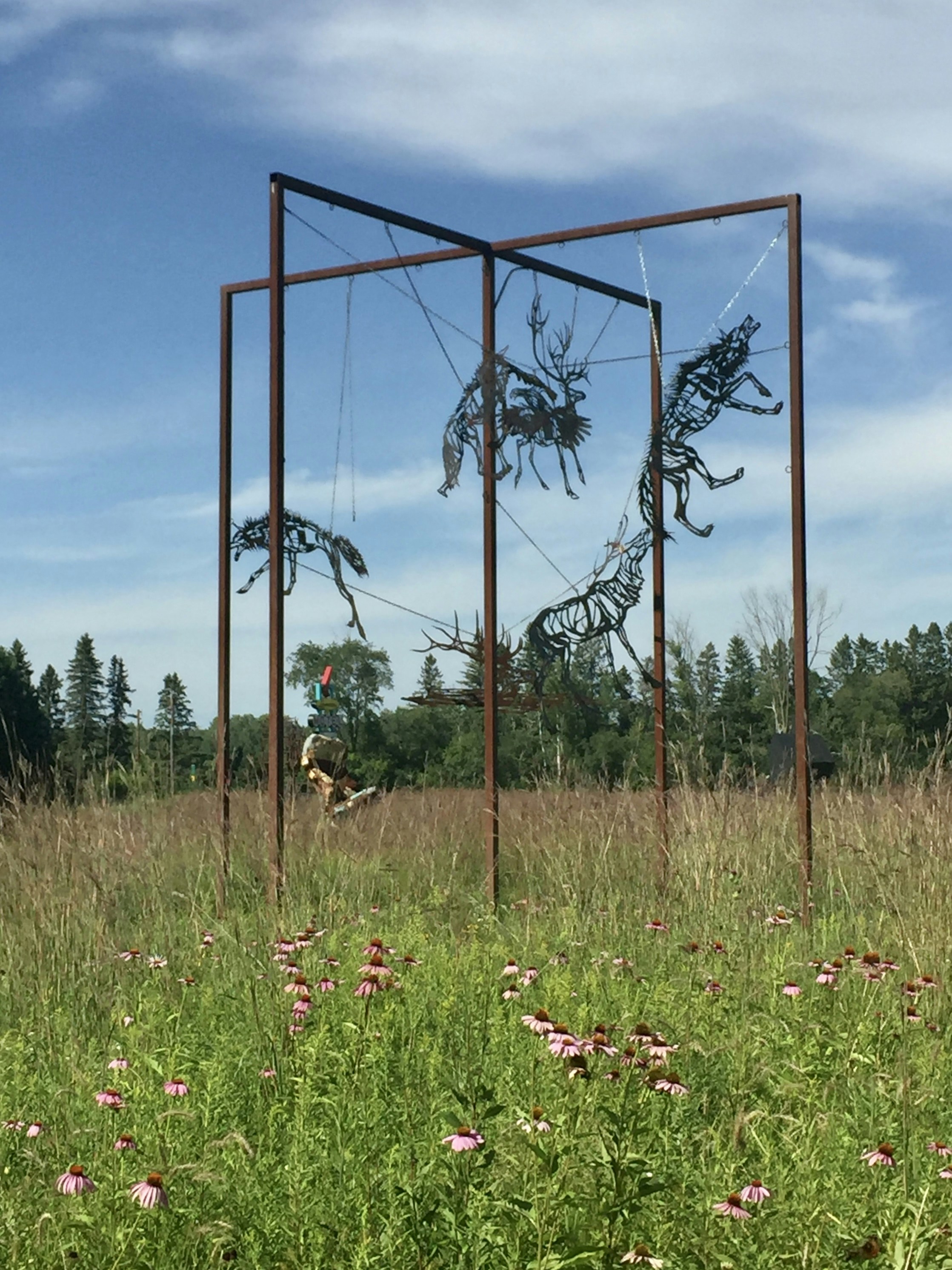 Rust-Frame Meadow: Spidery Metal Sculpture in a Prairie Field