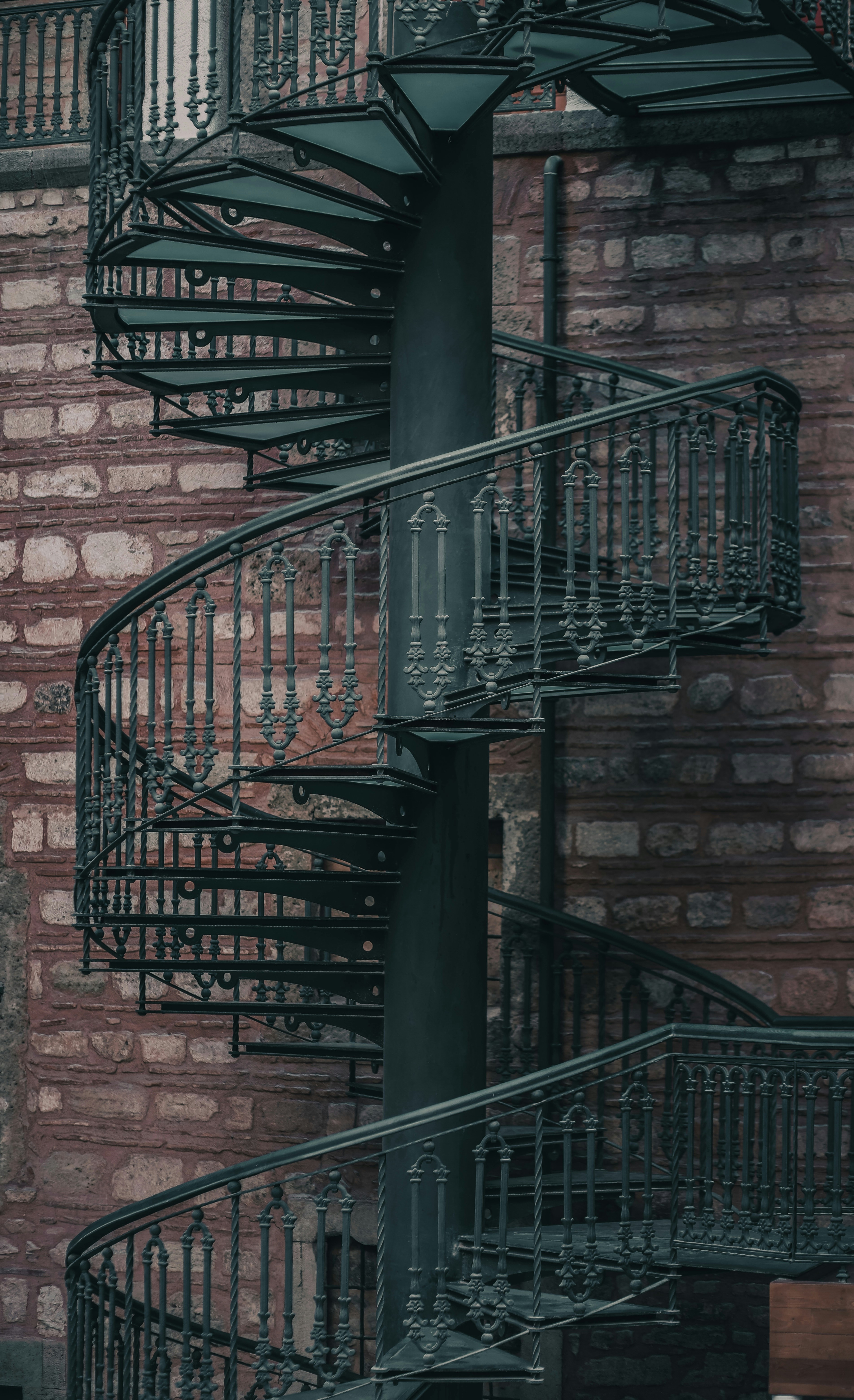 A black iron railing on a brick building photo – Free Grey Image on ...
