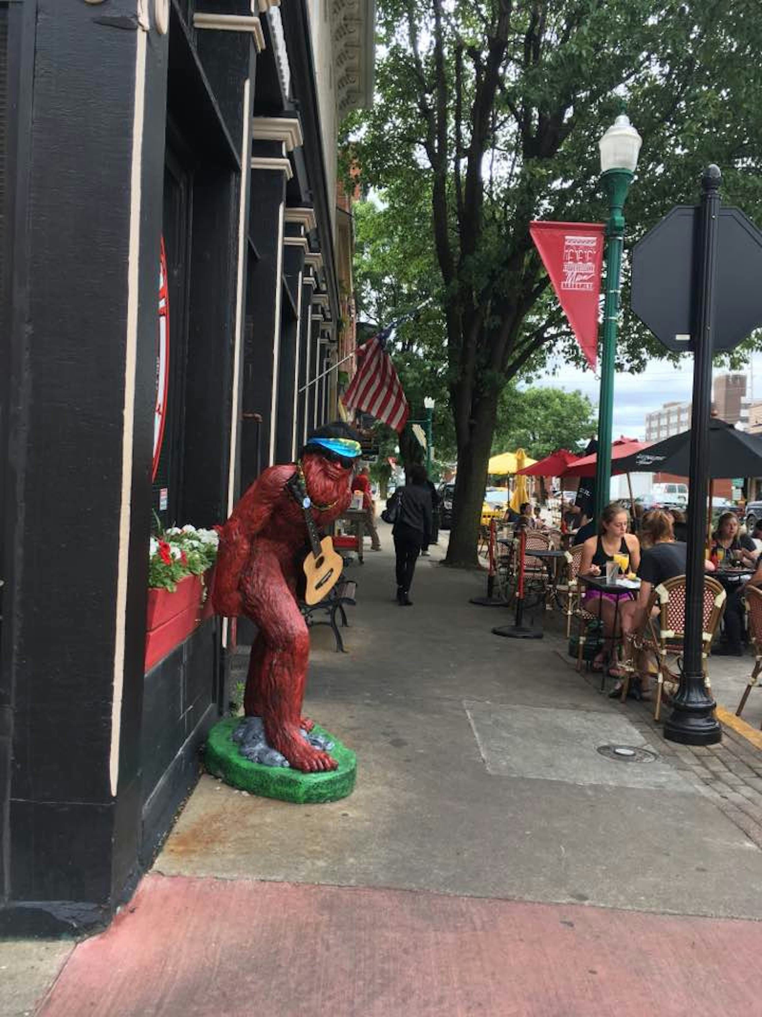 A person in a garment playing a saxophone on a sidewalk photo – Free ...