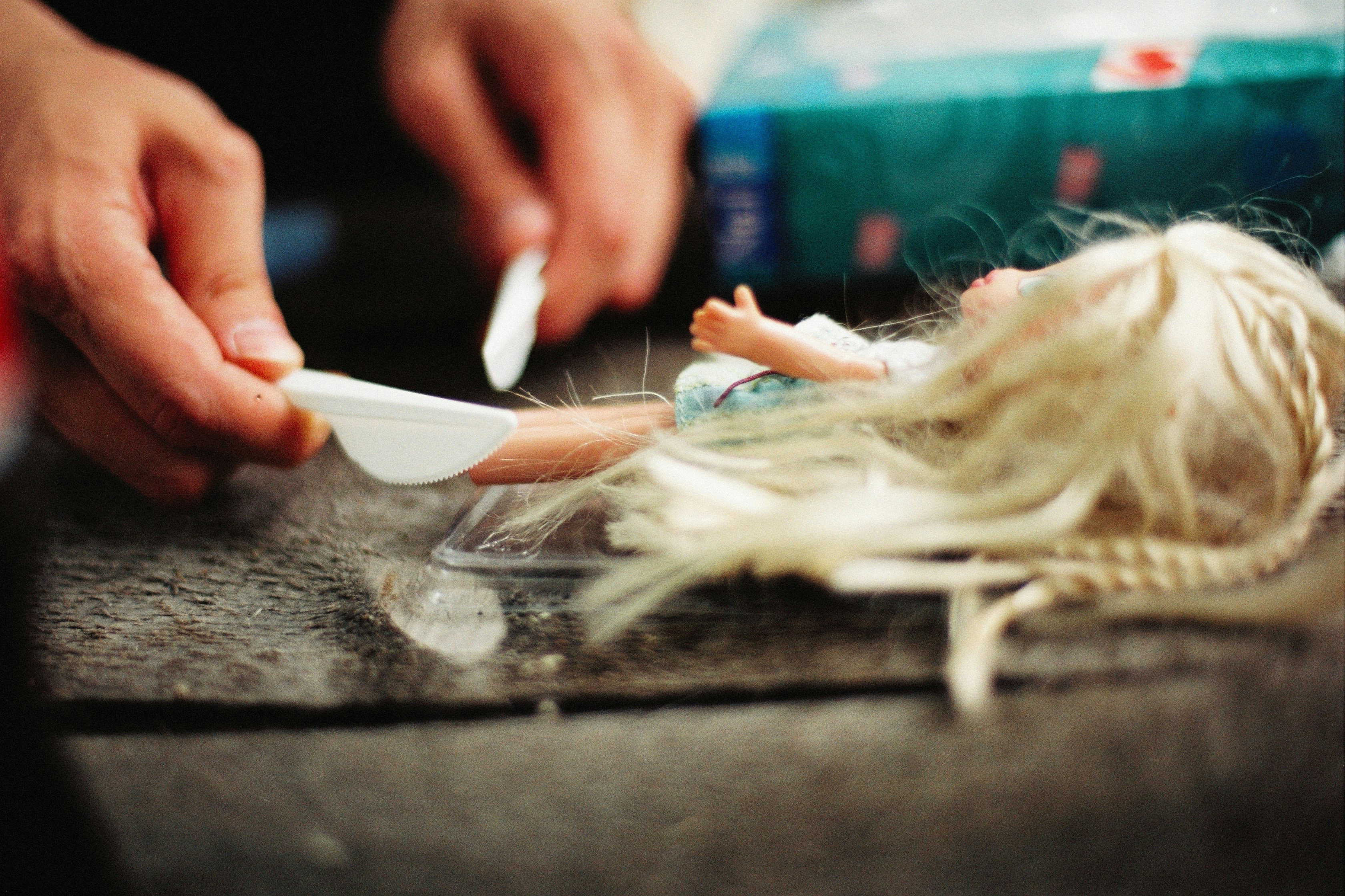 Frayed Threads and a Tiny Rescue: A DIY Moment on a Wooden Table
